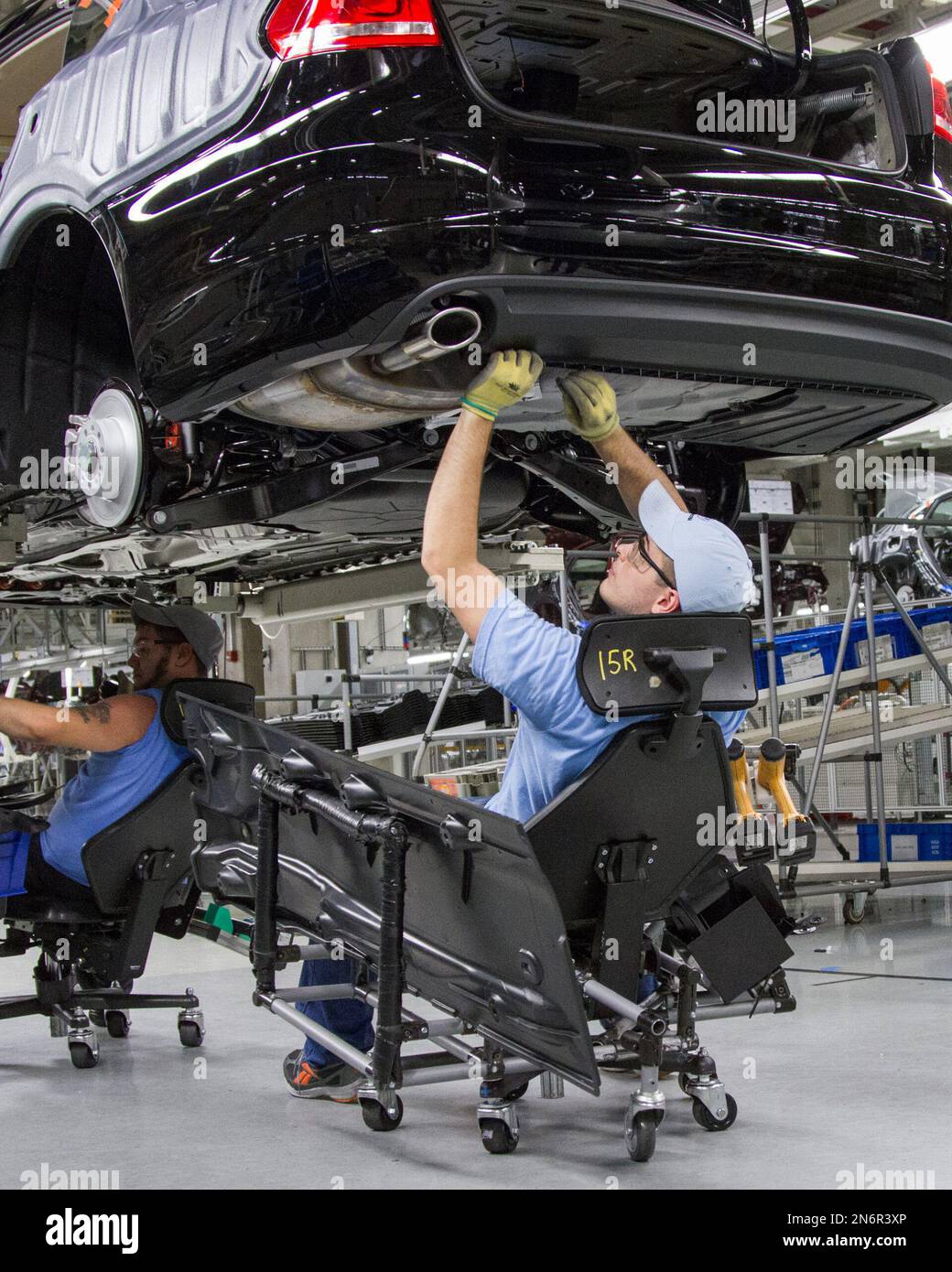 In this July 12, 2013, photo, an employee at the Volkswagen plant in ...