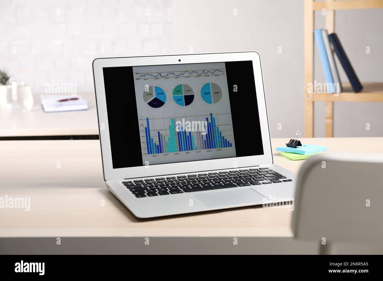 Laptop with different graphics on screen. Modern workplace Stock Photo ...