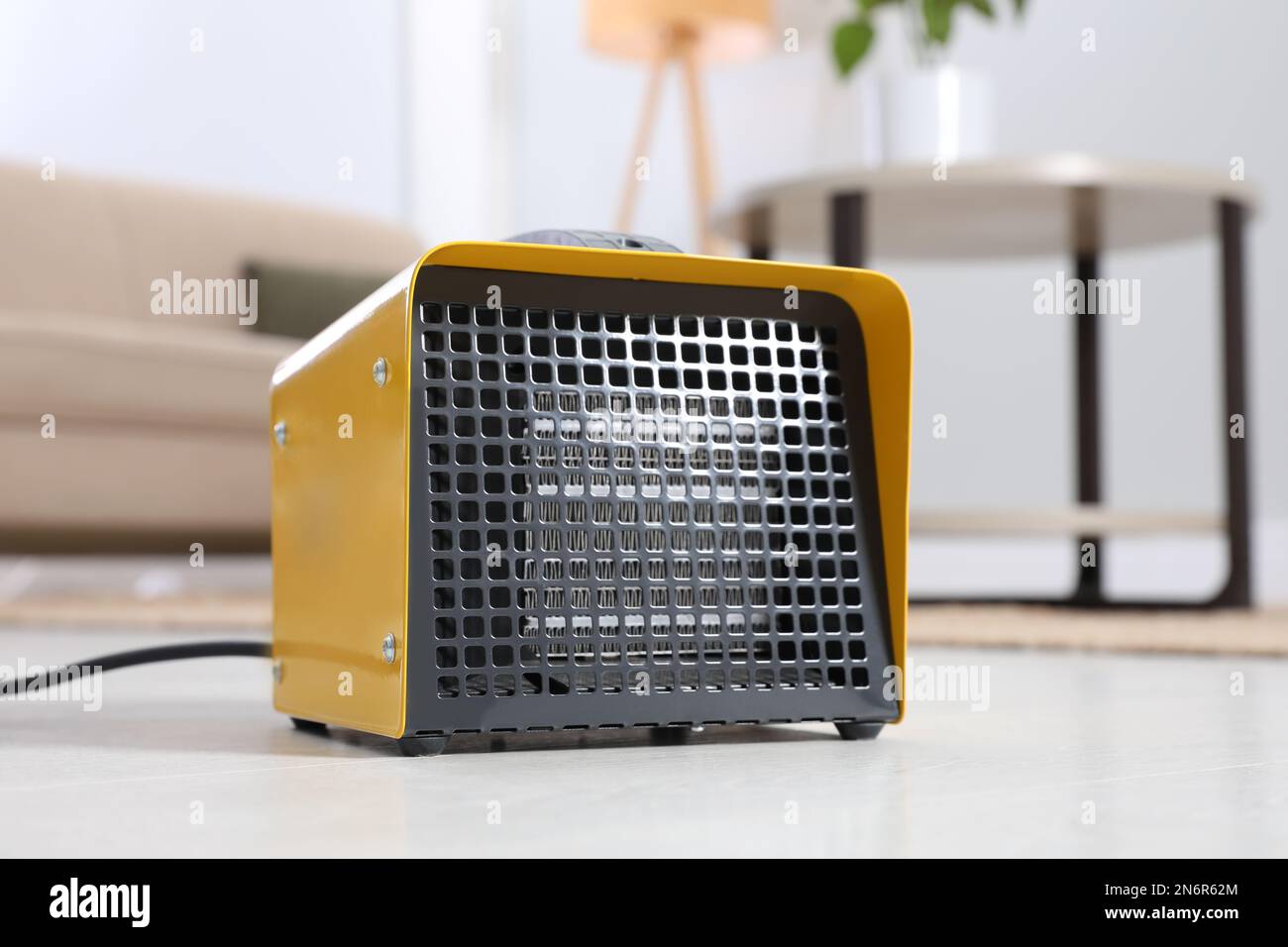 Modern electric heater on floor at home Stock Photo - Alamy
