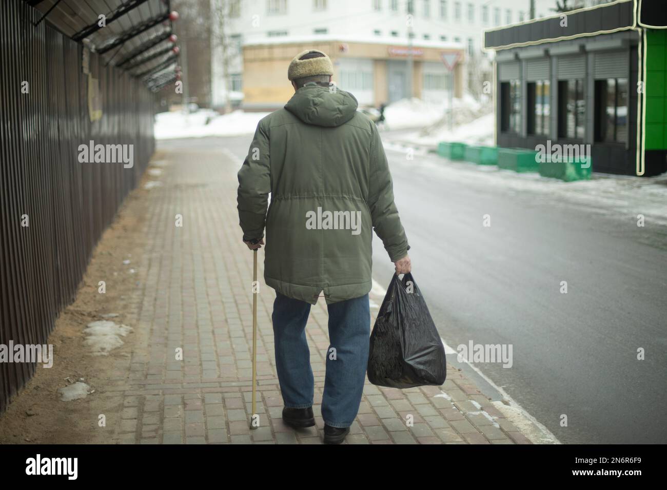 Pensioner Walks With Bag In His Hand Man With Walking Stick Man On