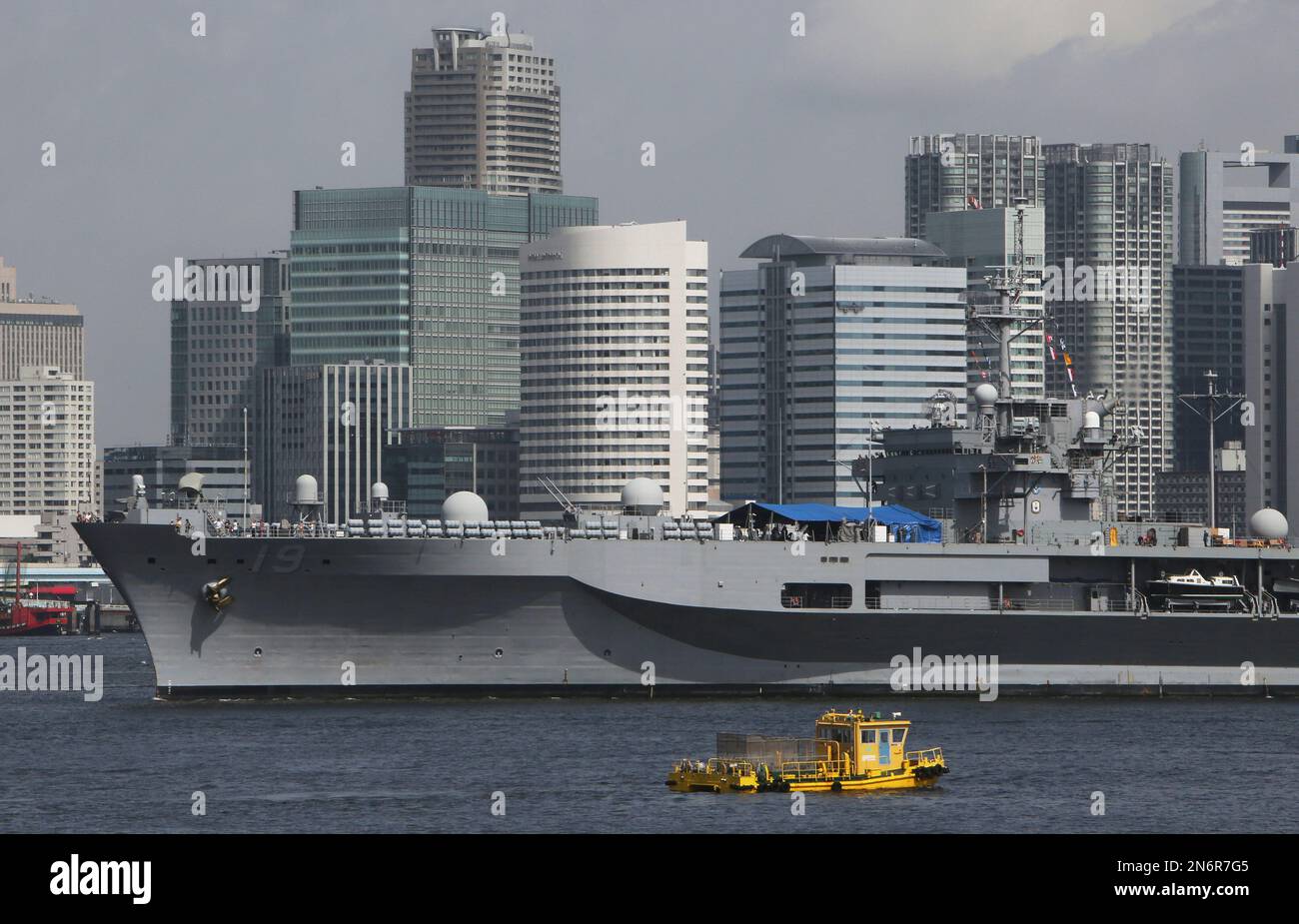 The USS Blue Ridge passes buildings on the Tokyo skyline as it sails ...