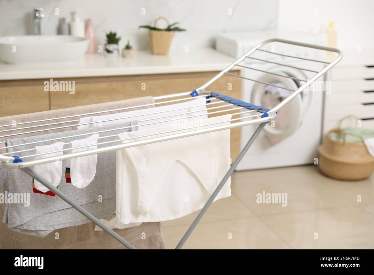 Clean laundry hanging on drying rack in bathroom, closeup Stock Photo ...