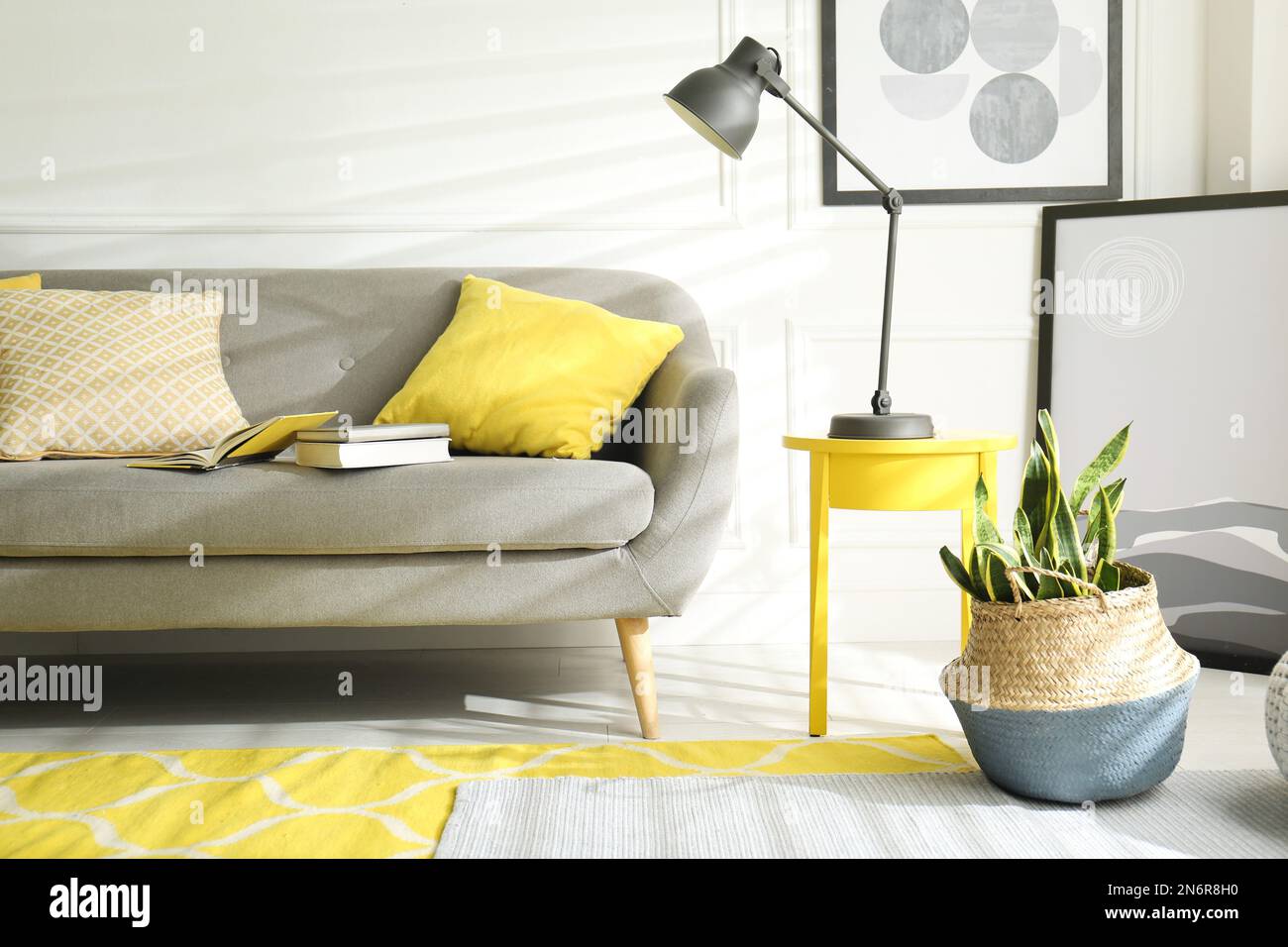 Stylish living room with sofa. Interior design in grey and yellow ...