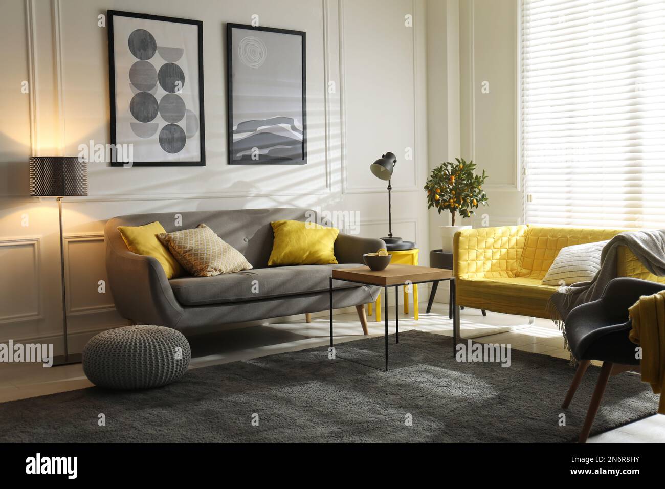 Stylish living room with sofas. Interior design in grey and yellow ...