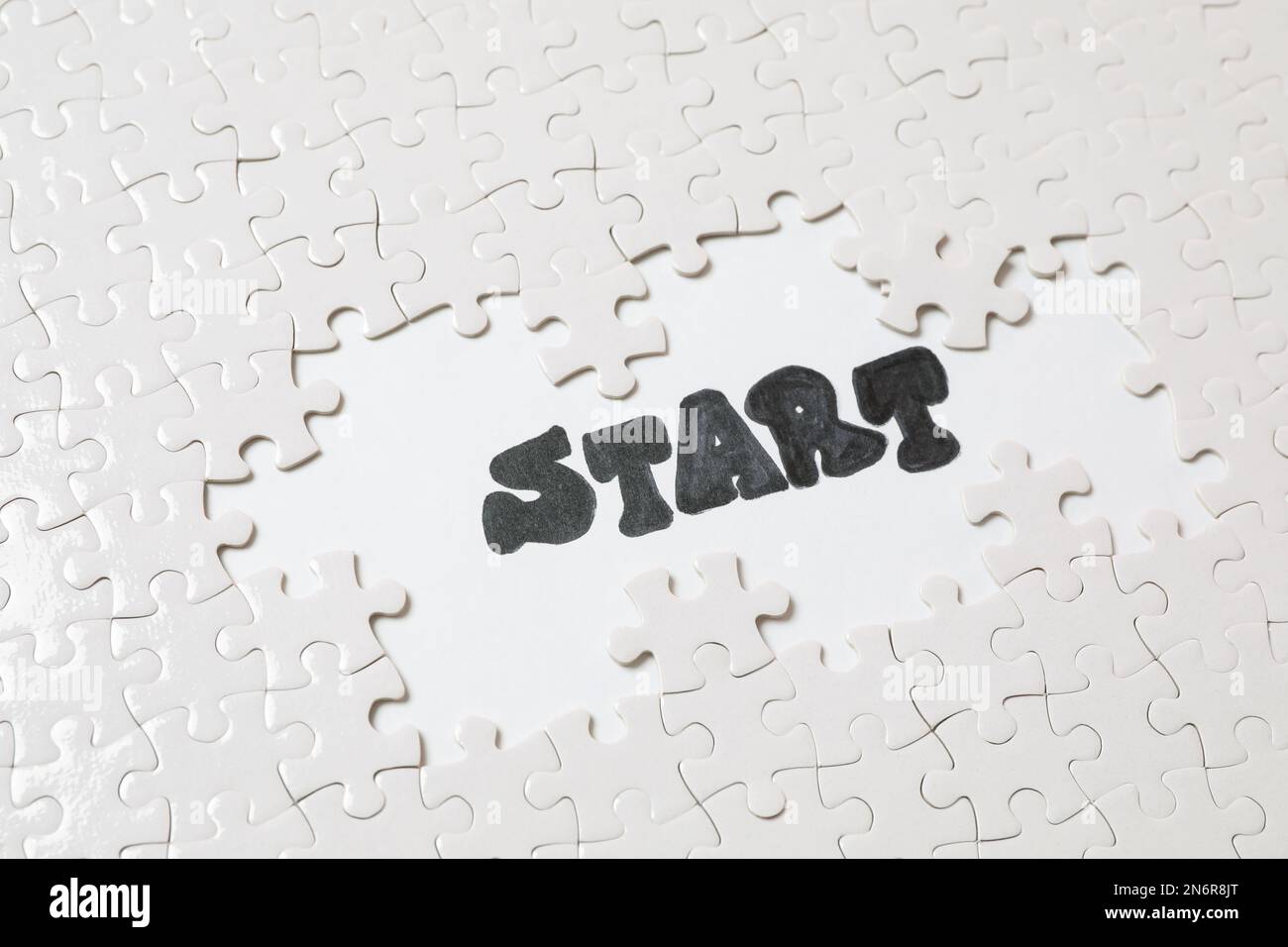 Puzzle pieces and word Start written on white background Stock Photo ...