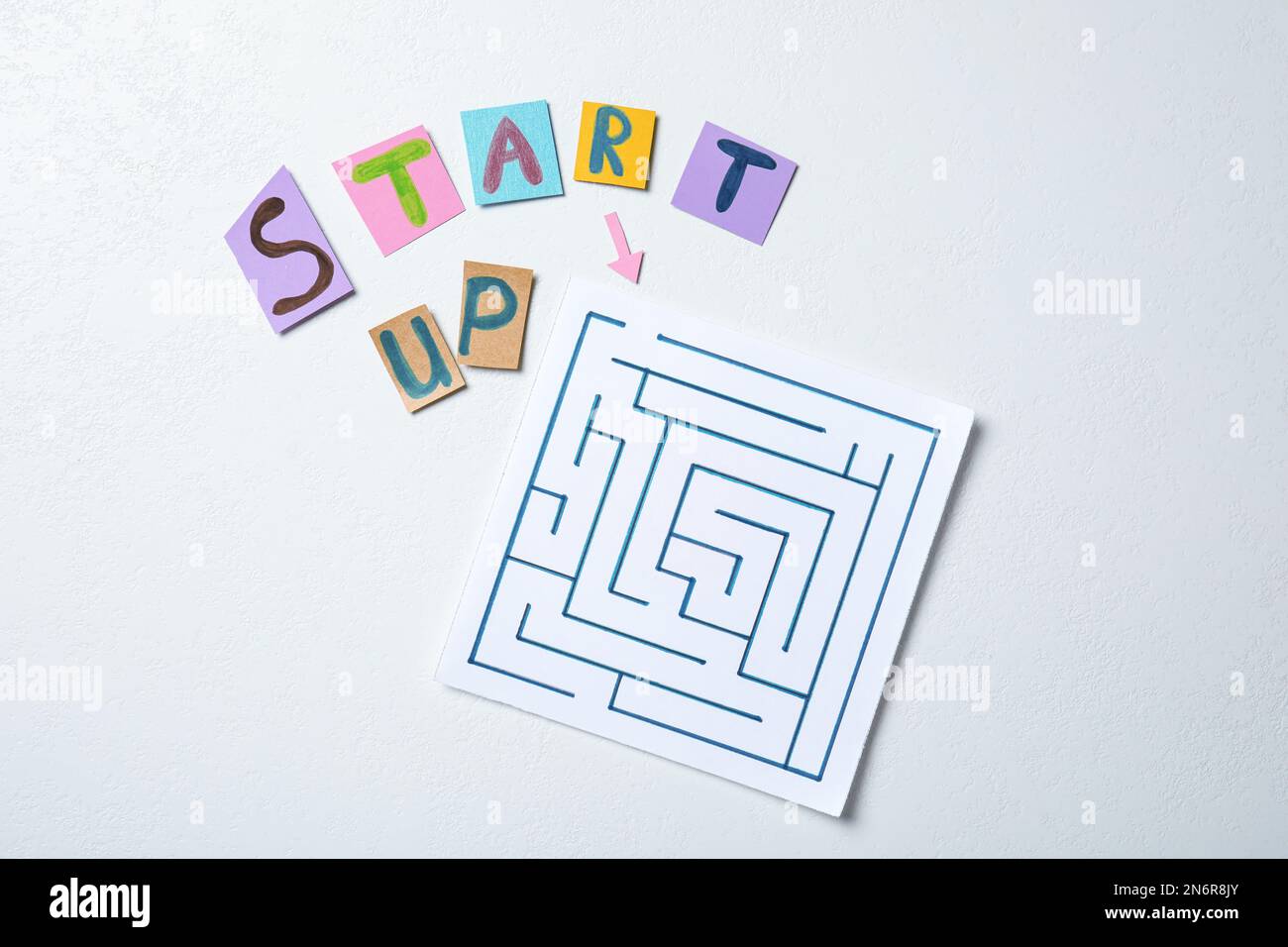 Sheets of paper with words Start Up and maze on white background, flat ...