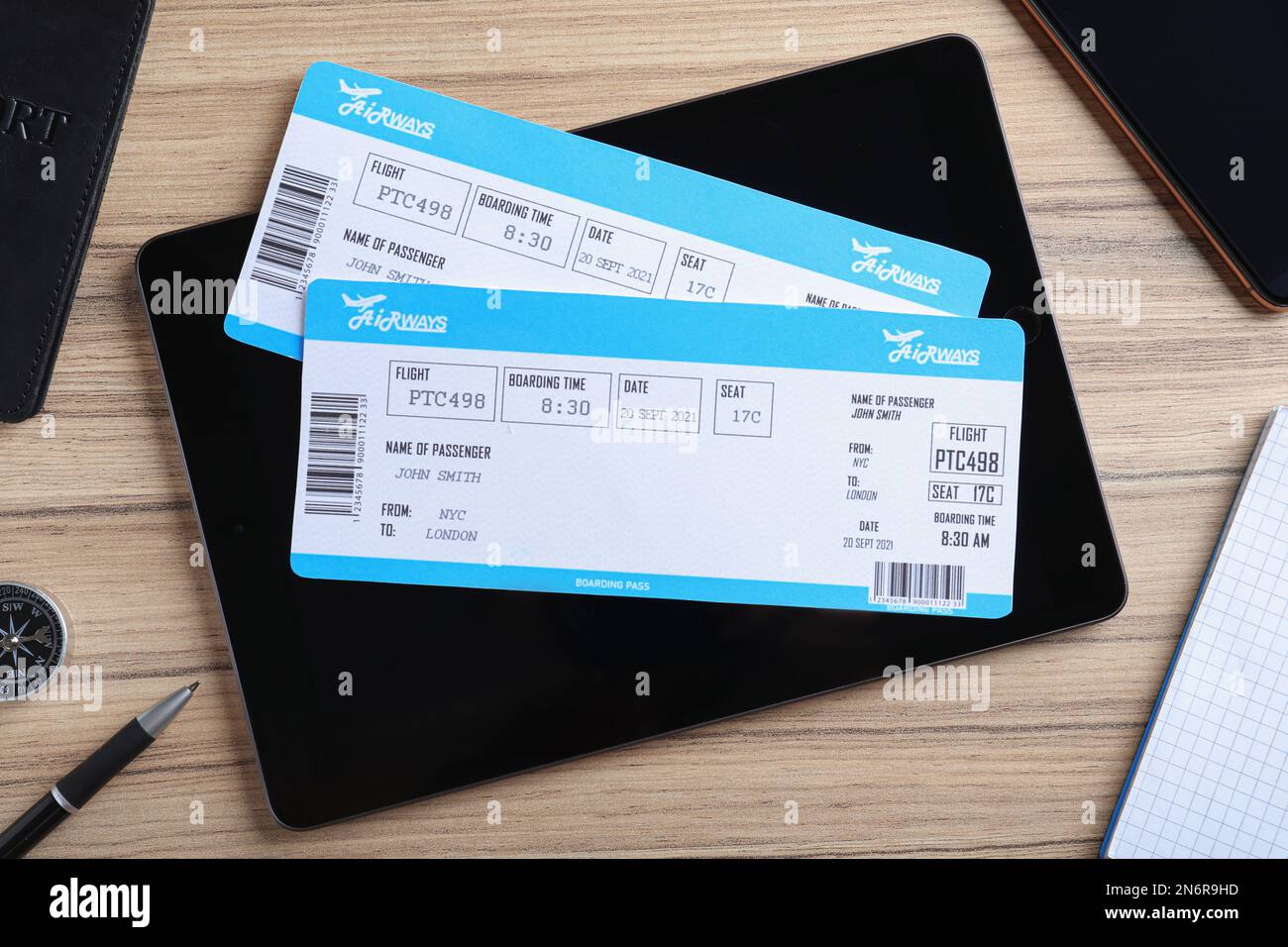 Flat lay composition with avia tickets and tablet on wooden table. Travel agency concept Stock ...