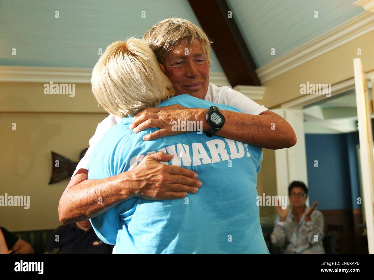 U.S. endurance swimmer Diana Nyad hugs one of her teammates during a ...