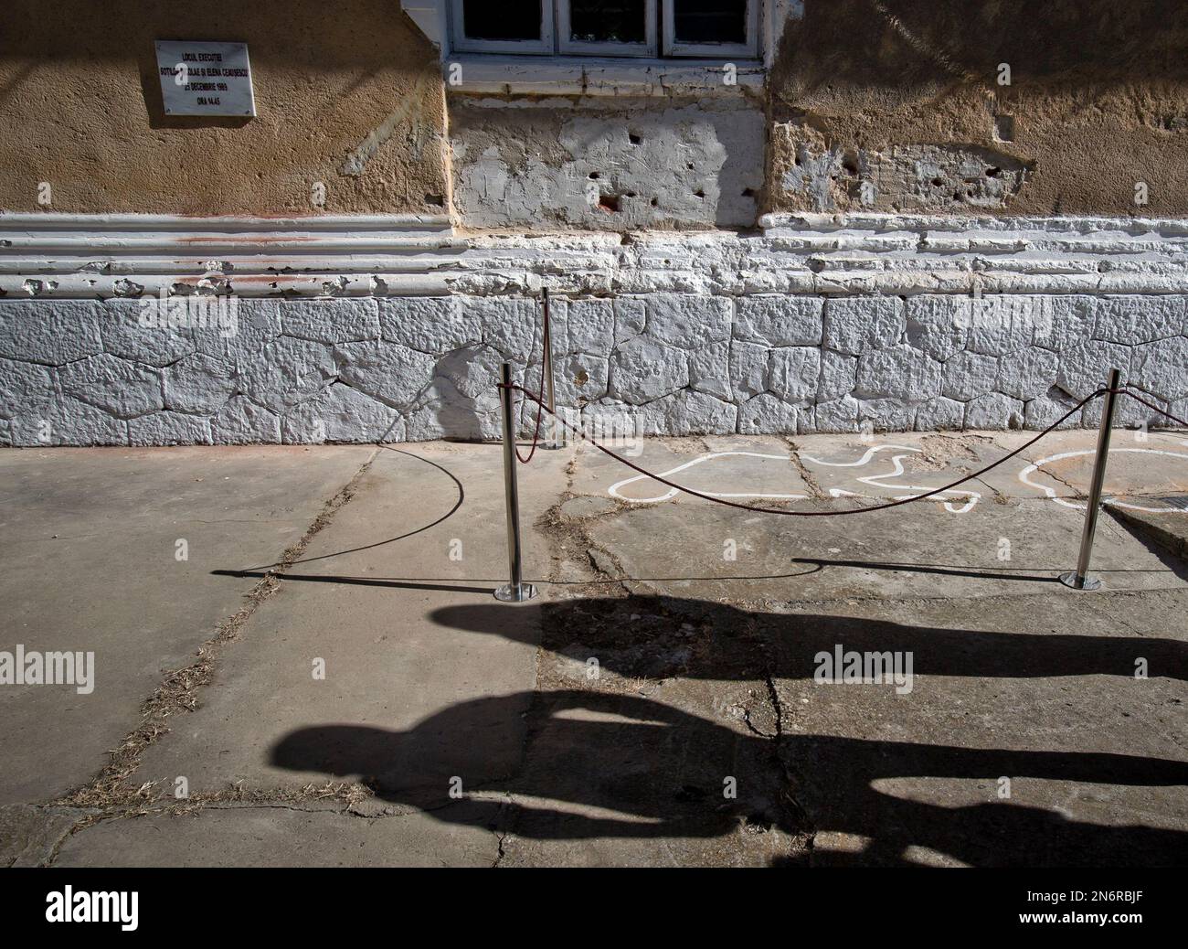 People cast shadows at the spot where Nicolae Ceausescu and his wife ...