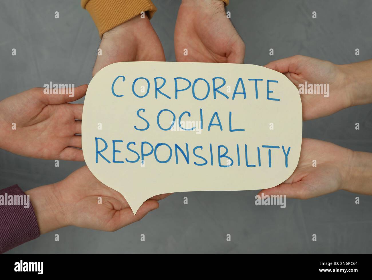 Top view of people holding paper text balloon with phrase Corporate ...