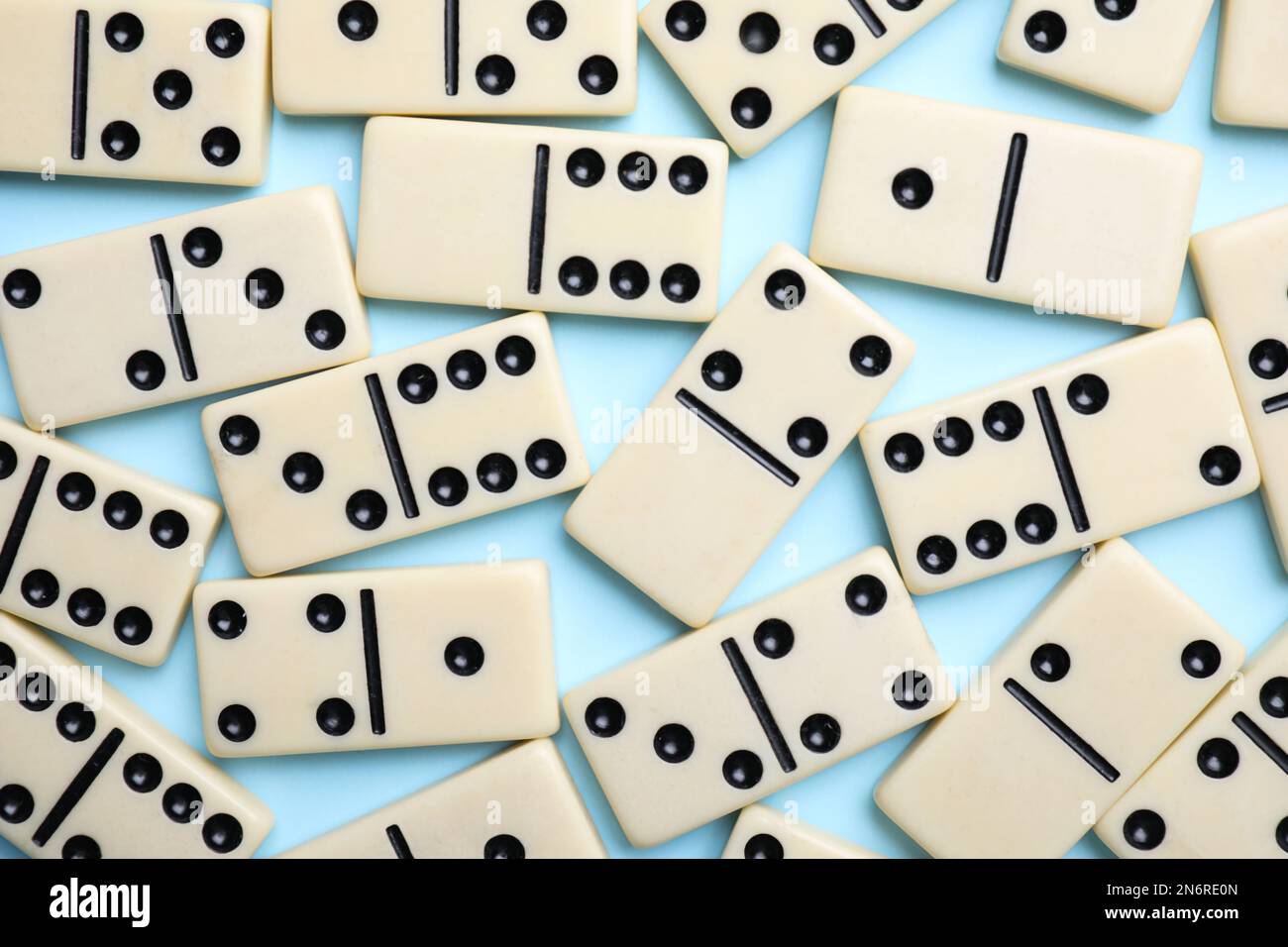 Classic domino tiles on light blue background, flat lay Stock Photo - Alamy