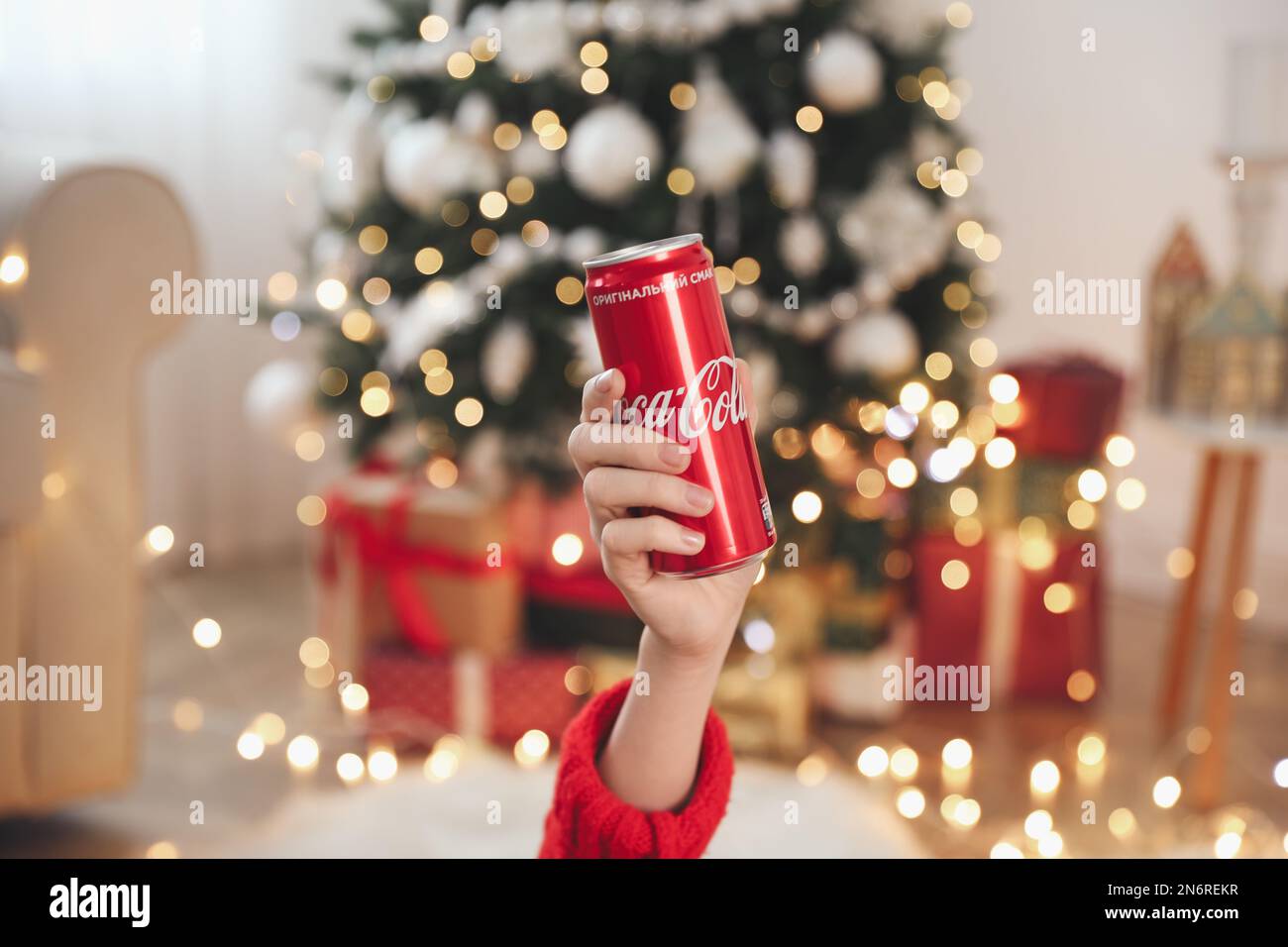 MYKOLAIV, UKRAINE - January 01, 2021: Woman with can of Coca-Cola ...