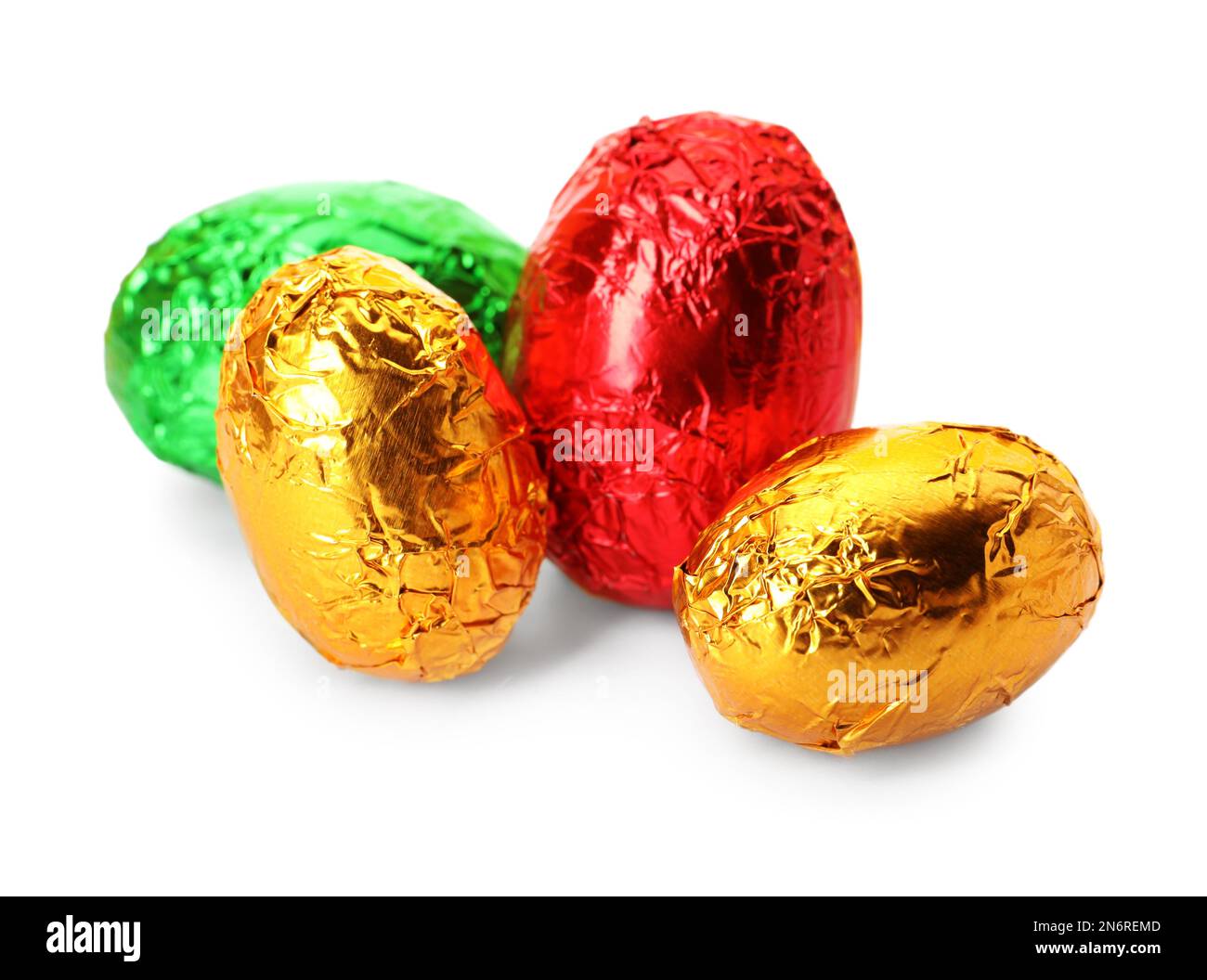Chocolate eggs wrapped in bright foil on white background Stock Photo ...
