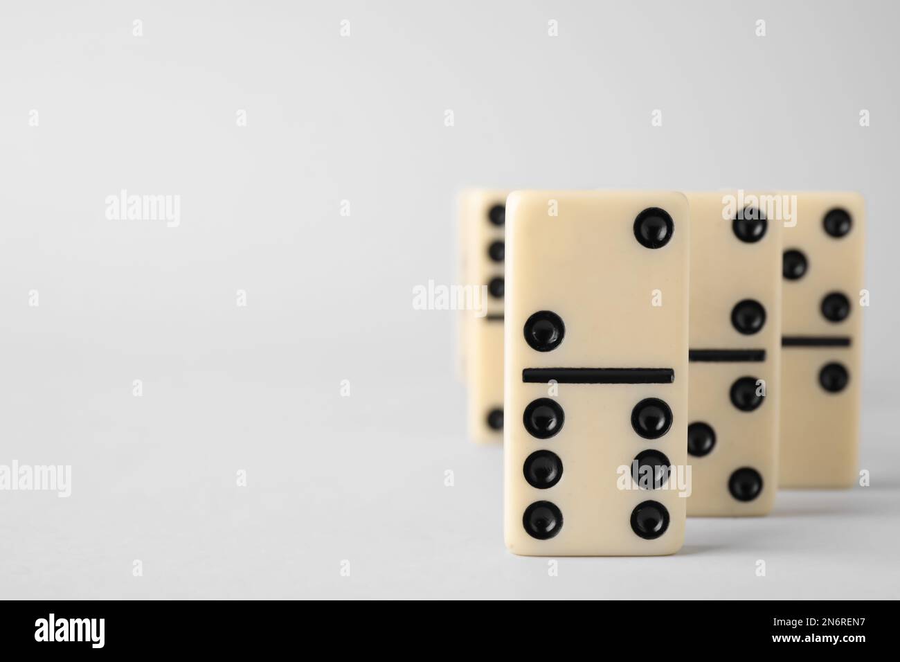 Domino tiles on white background. Space for text Stock Photo - Alamy