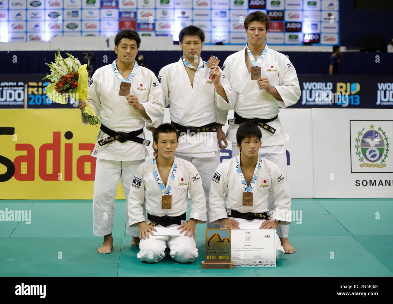 Japan men's national Judo Team poses for a photo holding their bronze ...