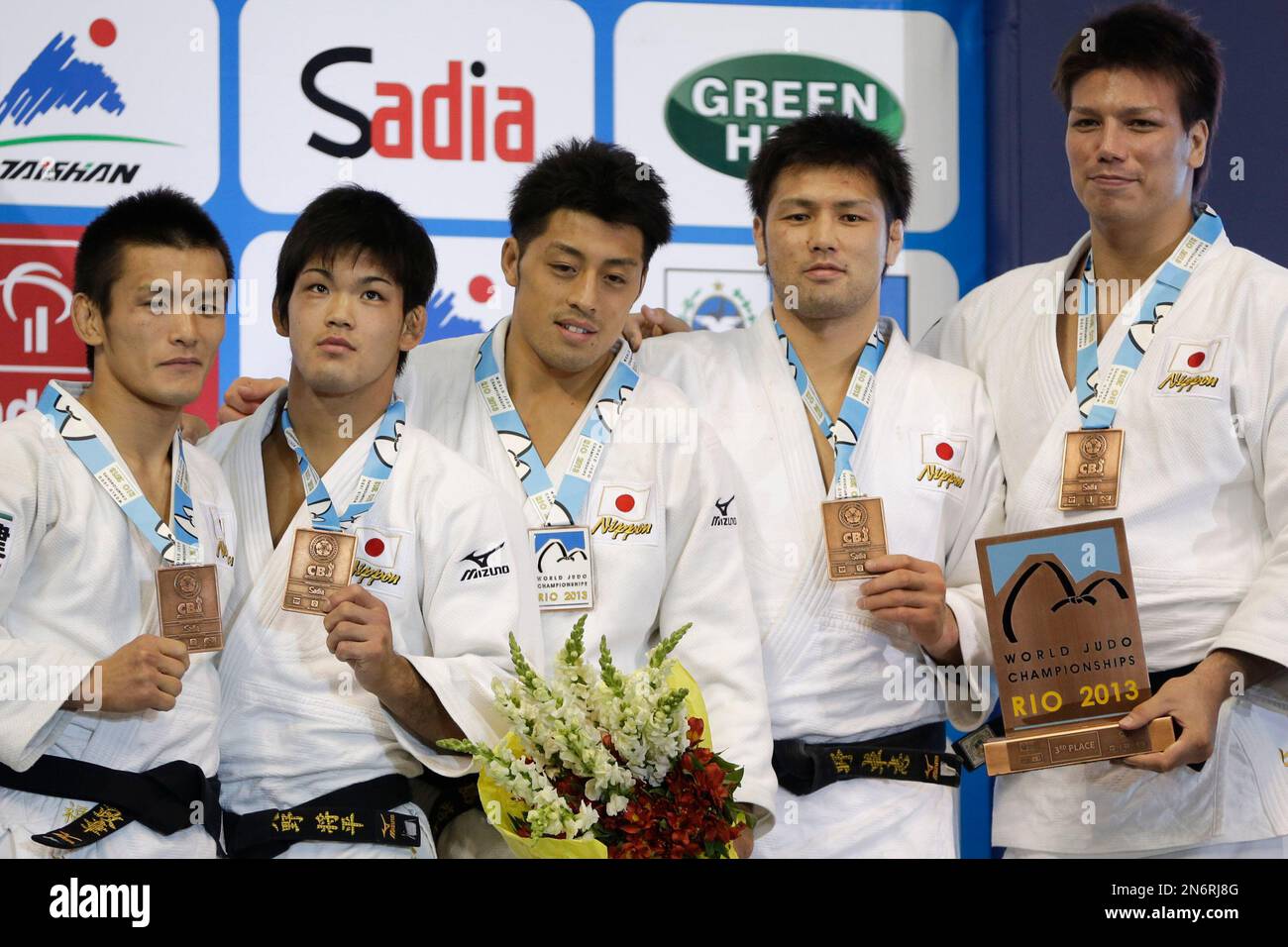 Japan men's national Judo Team poses for a photo holding their bronze ...