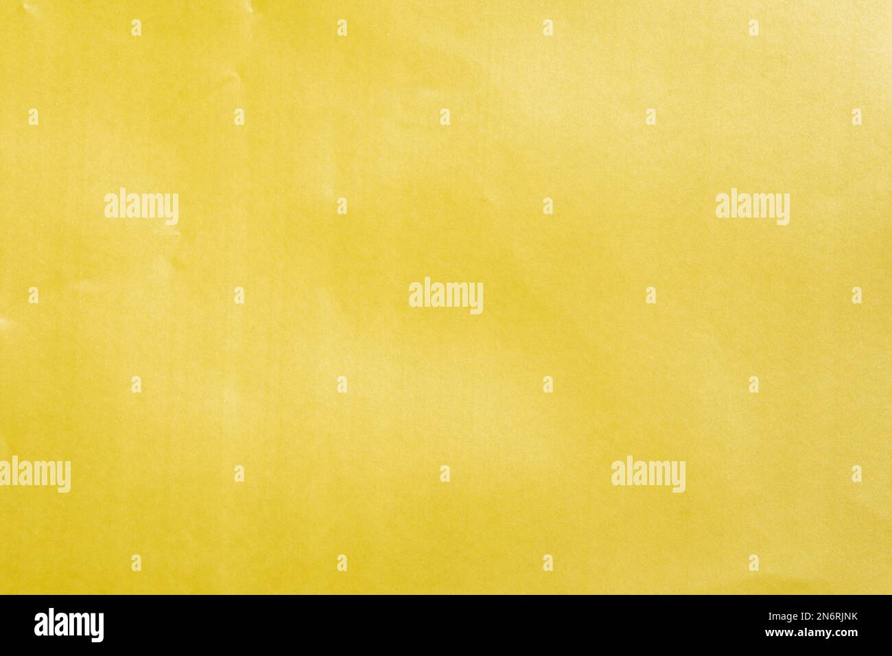 an empty wrinkled yellow gold pearl tissue paper textured background ...