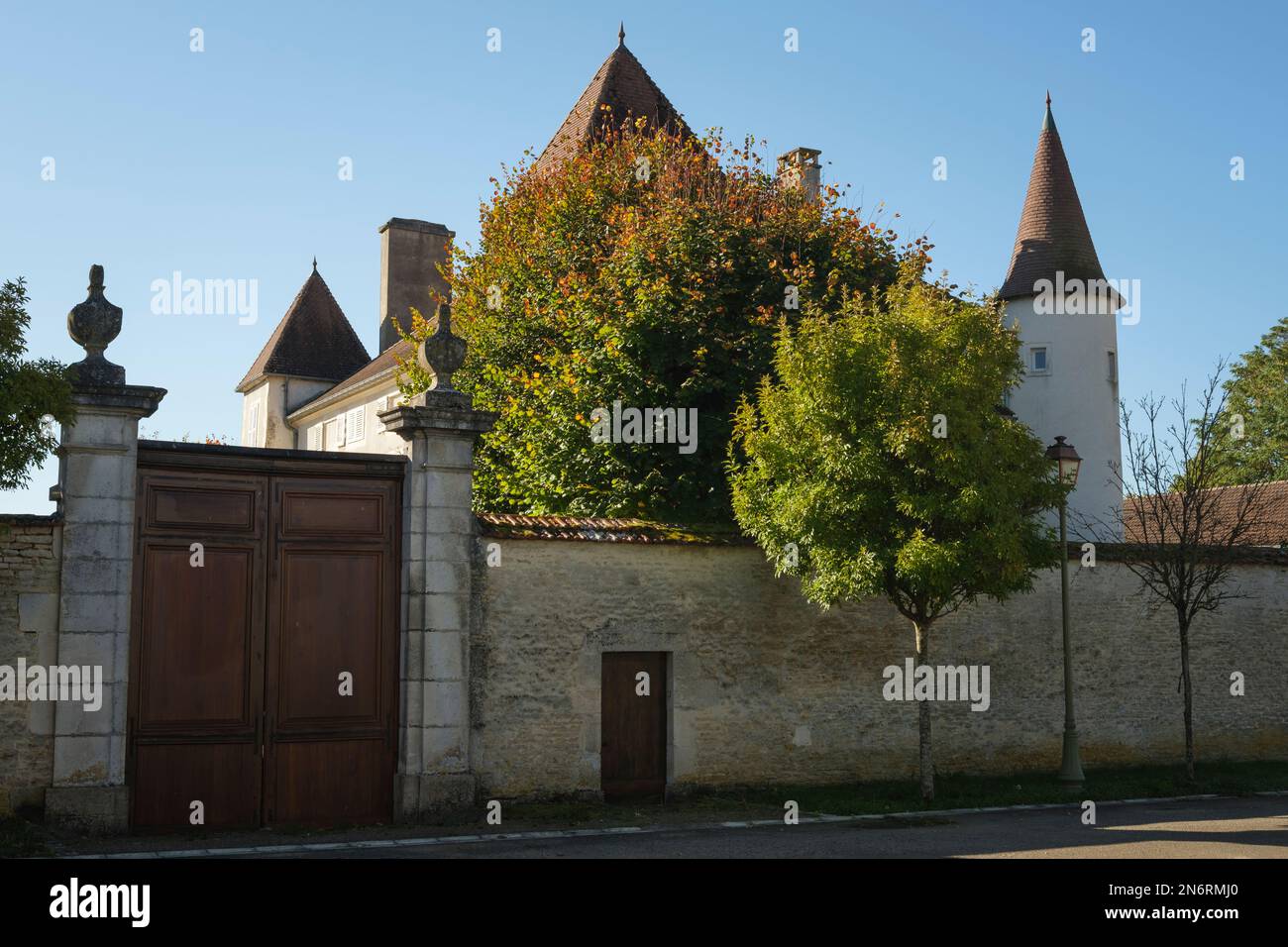 Typical historical chateau behind the high walls in the village in ...