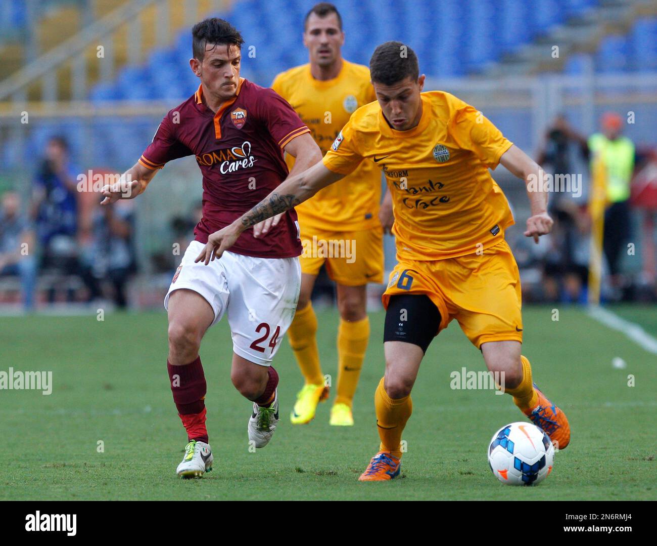 Hellas Verona midfielder Andrea Lazzari is challenged by AS Roma ...