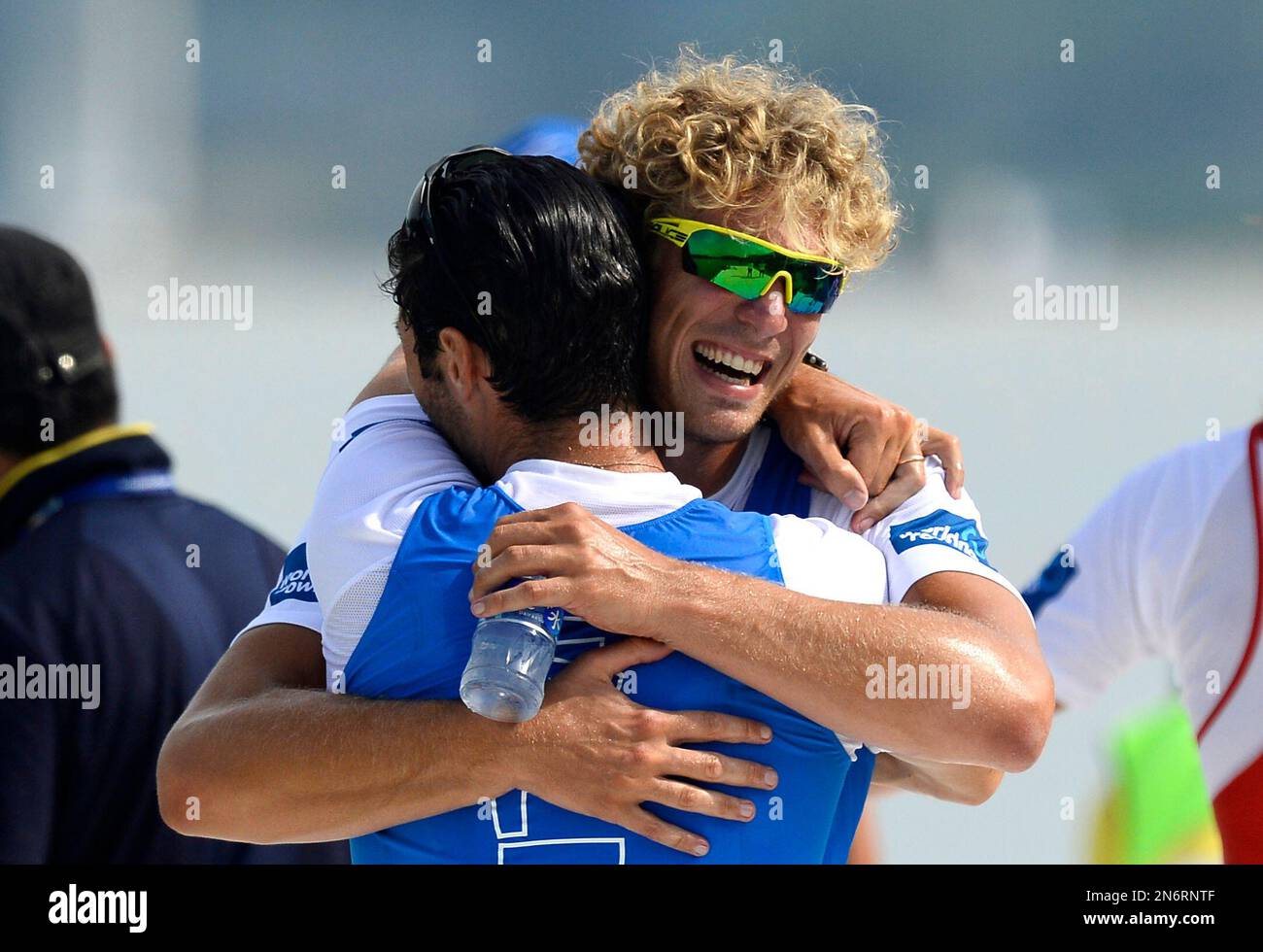 Third-placed Francesco Fossi, right, and Romano Battisti of Italy hug ...