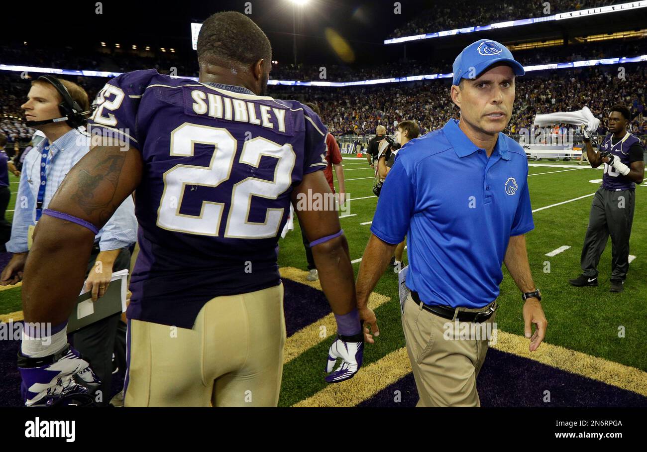 Boise State head coach Chris Peterson, right, walks off the field past ...