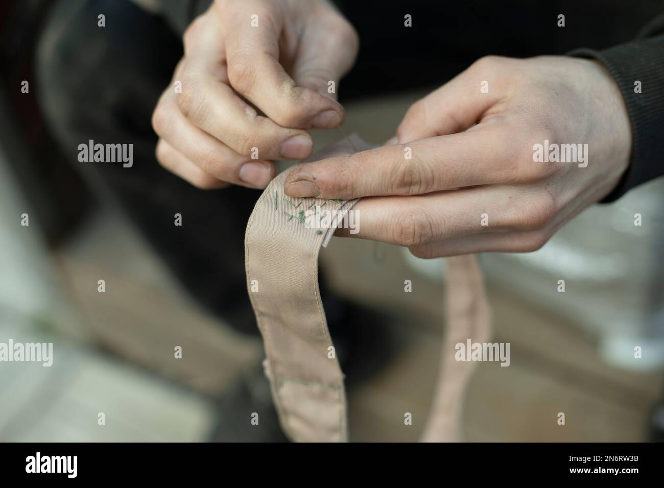 Sewing tape. Collar stitching in army. Work of weaver. Repair clothes ...