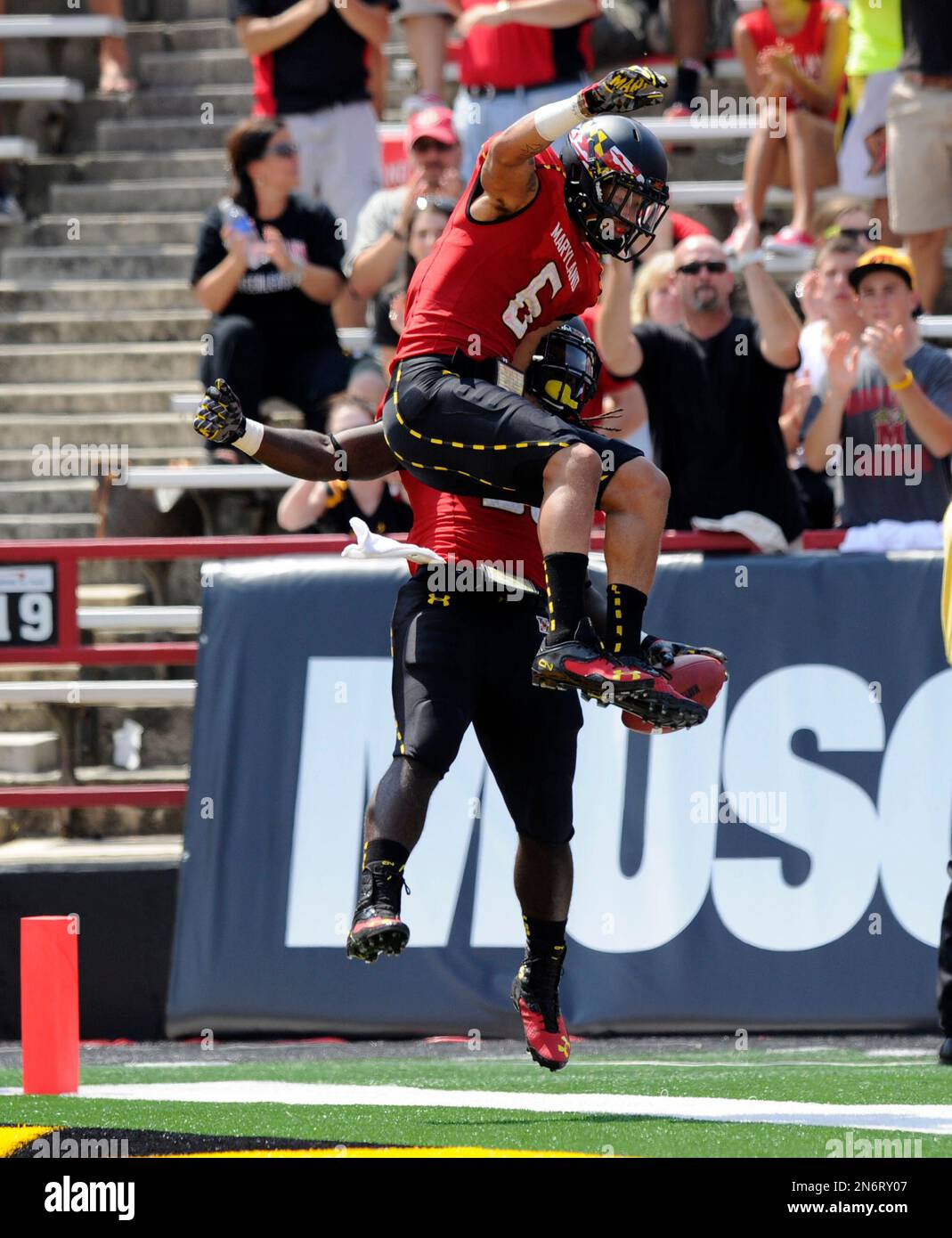 Maryland running back Kenneth Goins Jr., rear bottom, celebrates his ...
