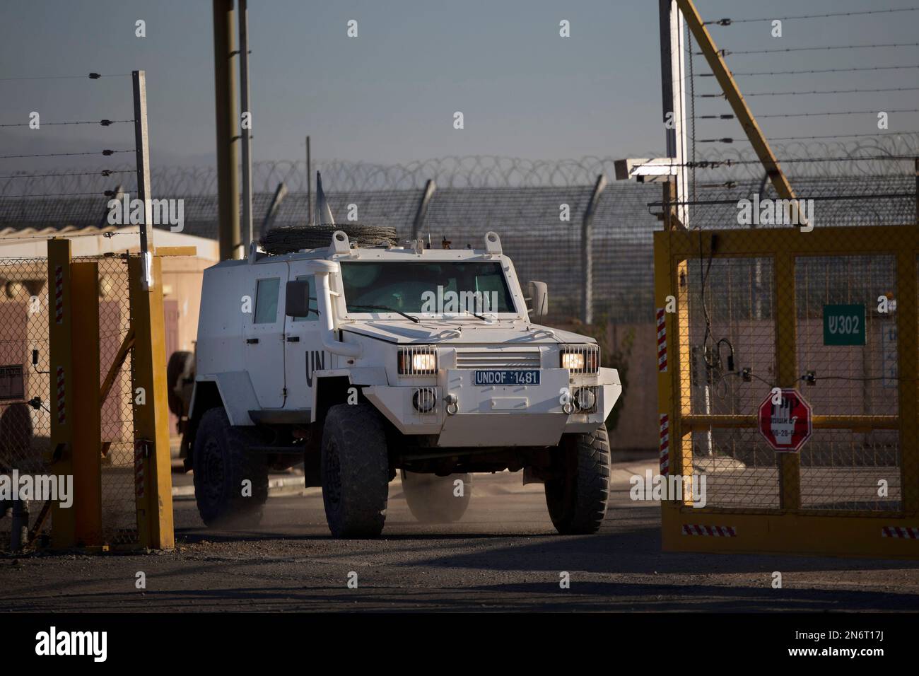 A U.N. armored vehicle crosses back from Syria at the Quneitra Crossing ...