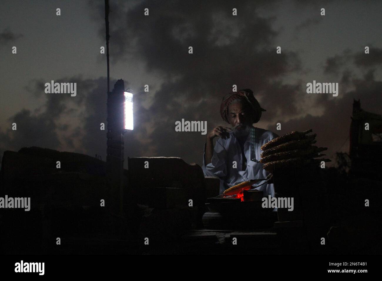A Pakistani vendor sells corn at the Karachi beach in Pakistan, Friday ...