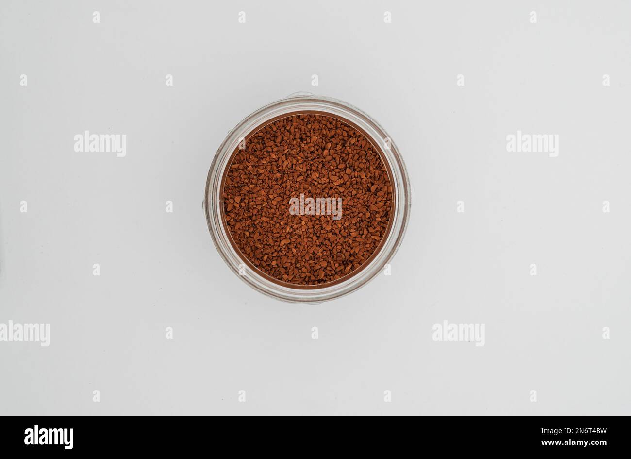Granular coffee. Top of view of granulated coffee in a glass jar with ...