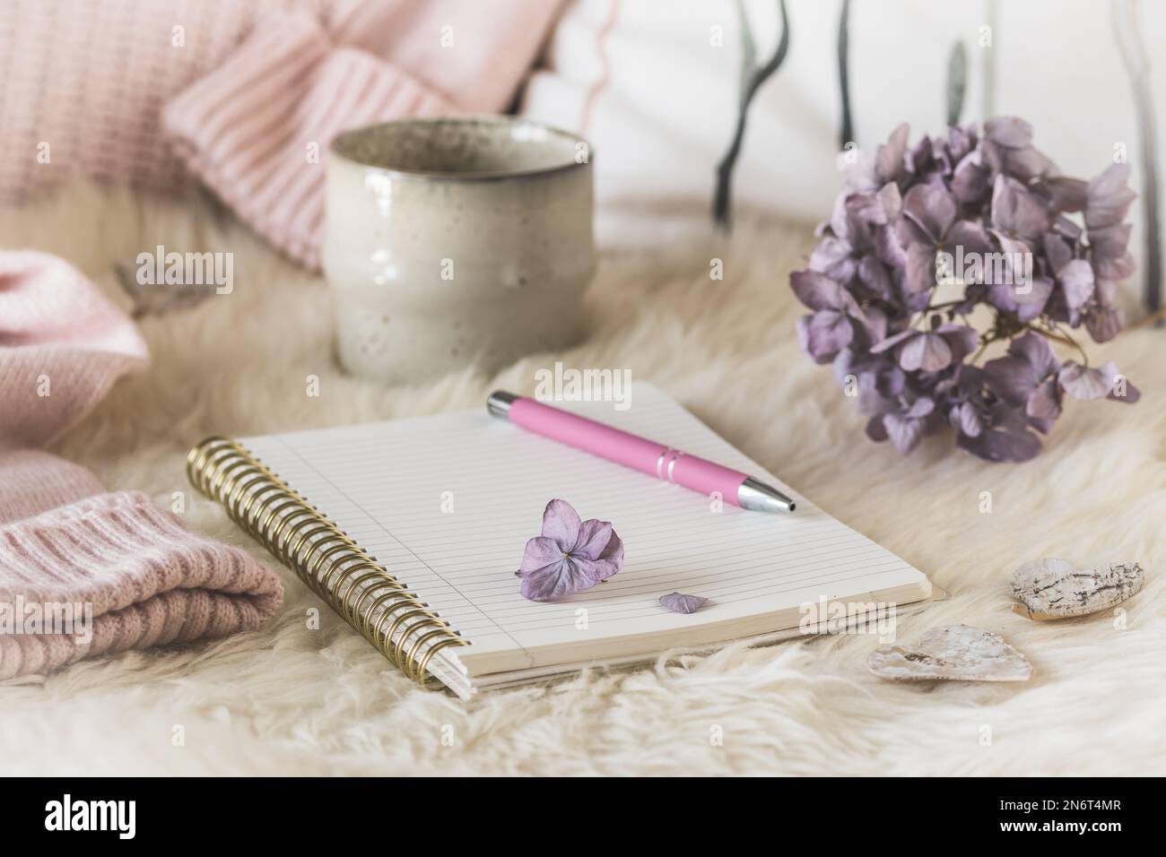 Cozy coffee break scene with notebook, cup and wool fabric, cream and ...