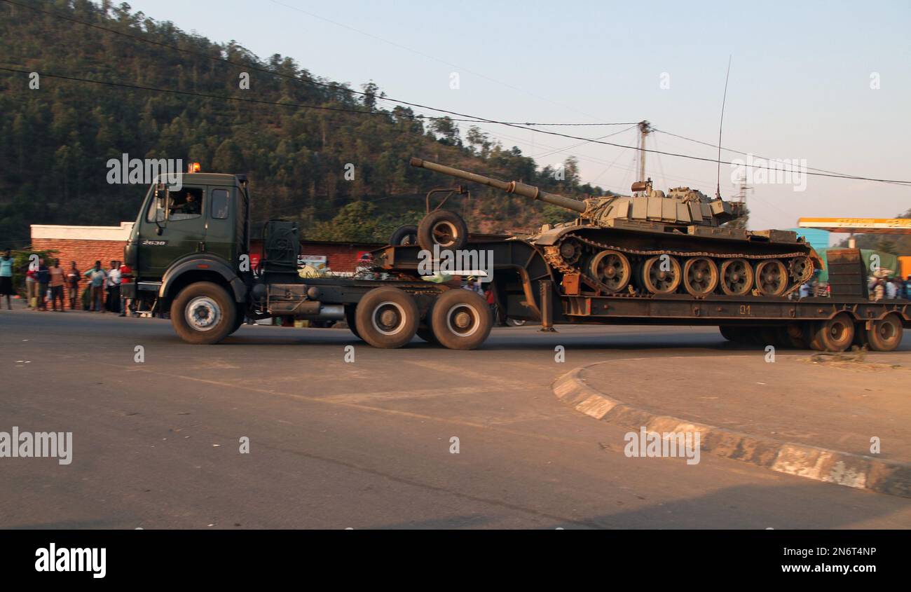 A trailer carrying a tank leaves the Rwandan capital Kigali en route to ...