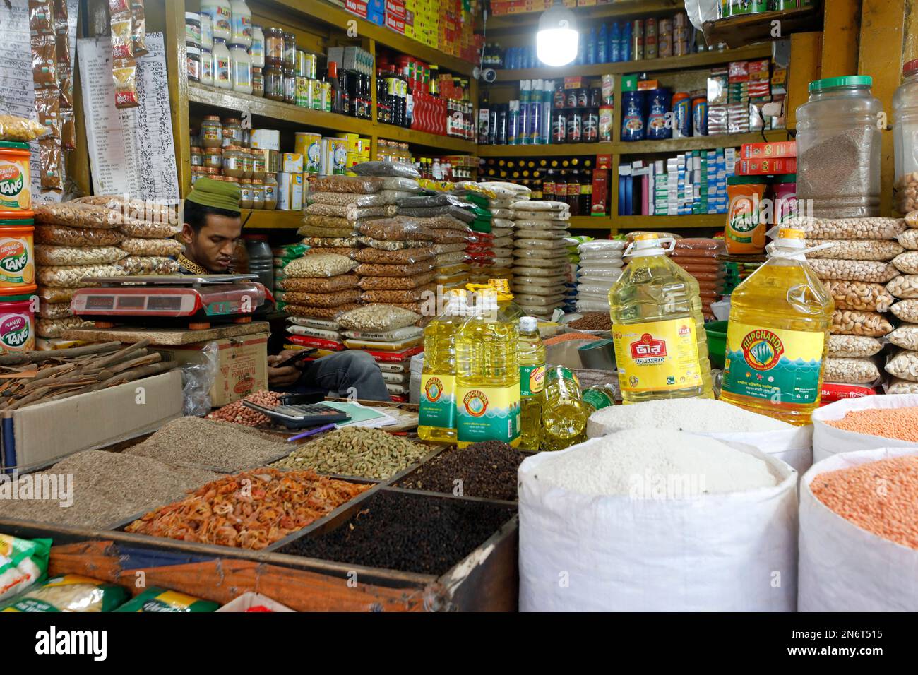 Dhaka, Bangladesh - February 10, 2023: Bangladeshi grocery vendors wait for customer at Karwan ...