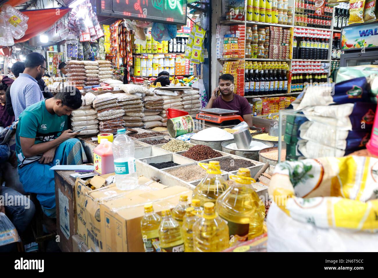 Dhaka, Bangladesh - February 10, 2023: Bangladeshi grocery vendors wait for customer at Karwan ...