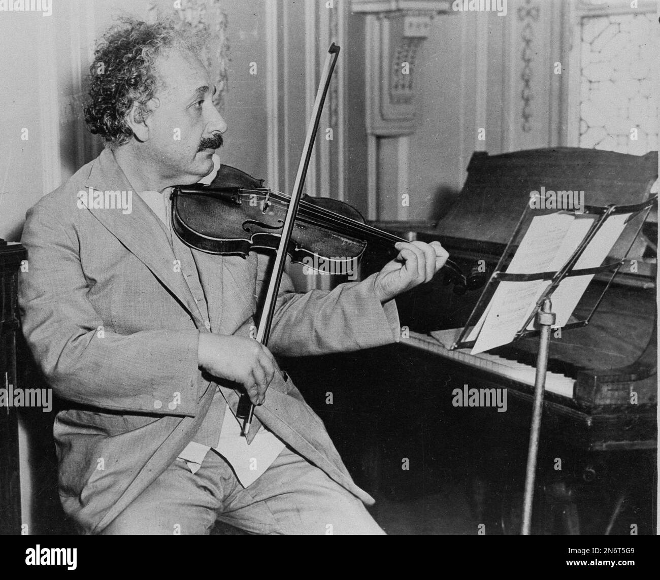 Famed physicist Albert Einstein is shown playing the violin, date and ...