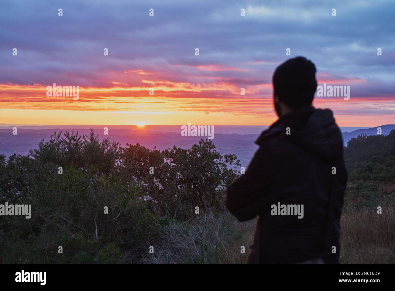 Silhouette of man at sunset Stock Photo - Alamy