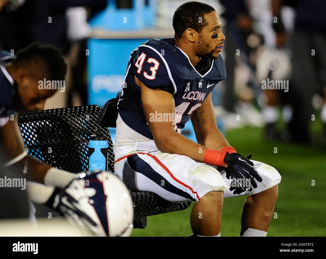 Connecticut running back Lyle McCombs (43) watches play in the final ...