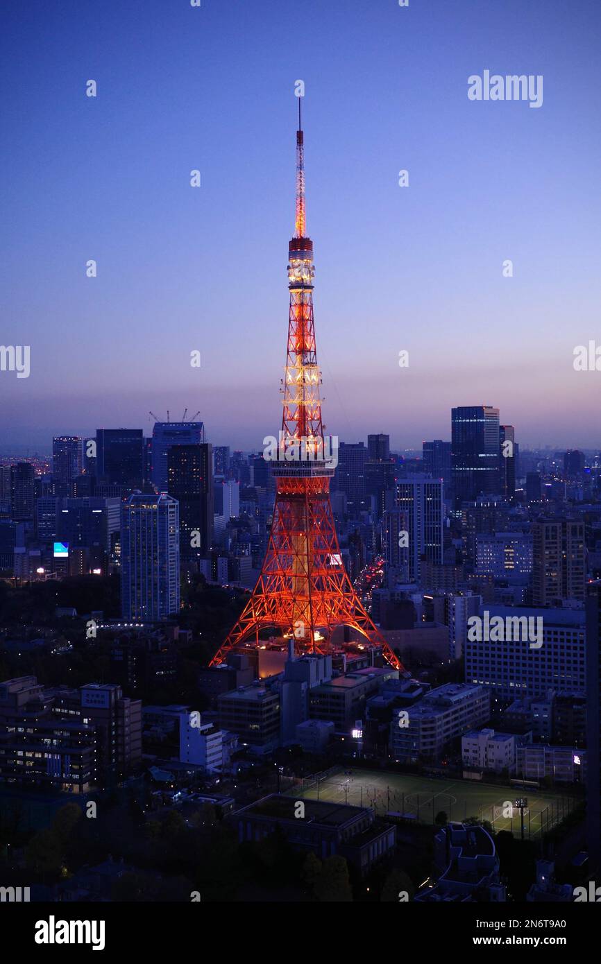 This striking image of Tokyo's iconic red Tower lit up against the blue ...