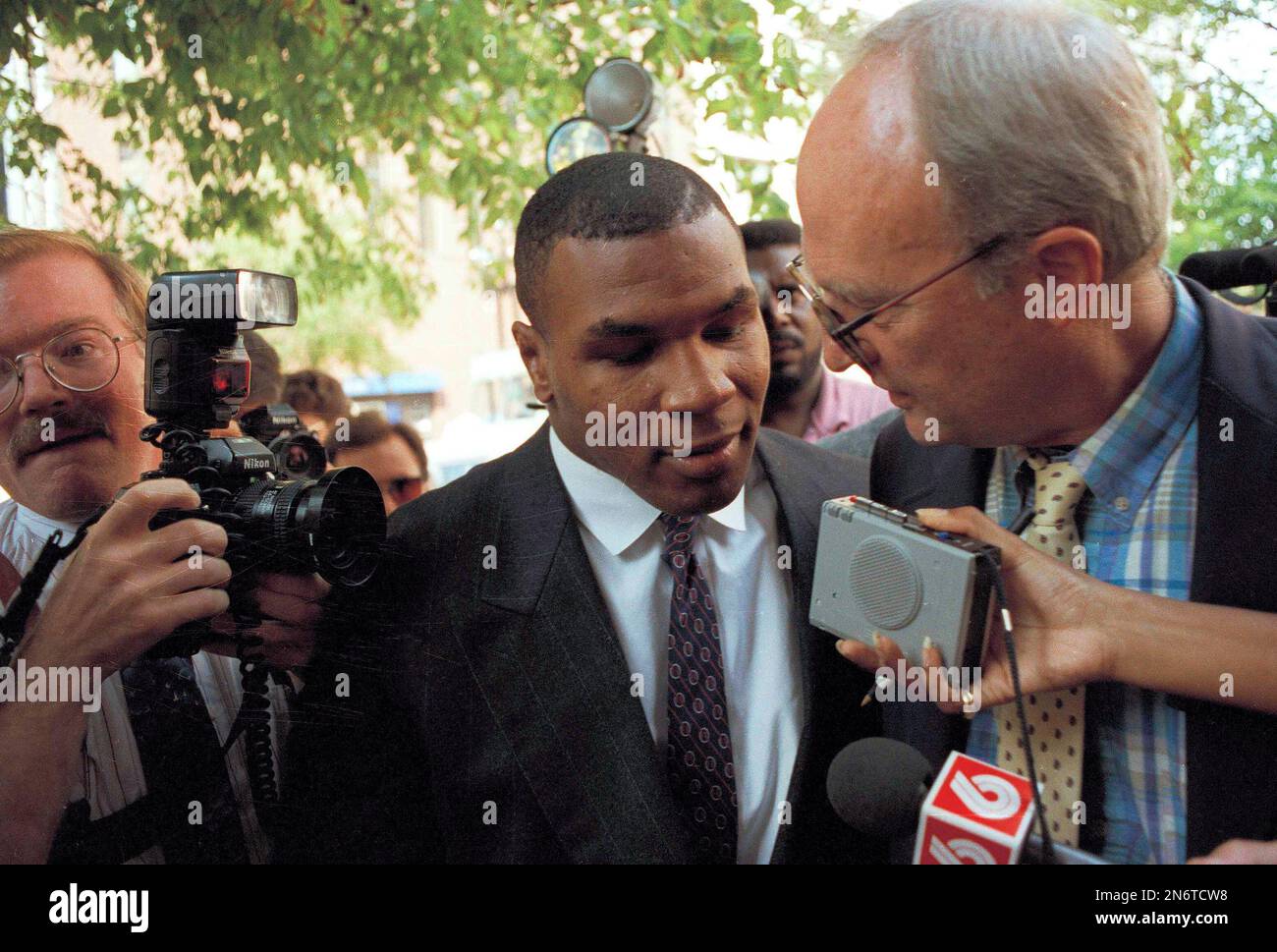 Former heavyweight champion Mike Tyson is questioned by reporters as he ...