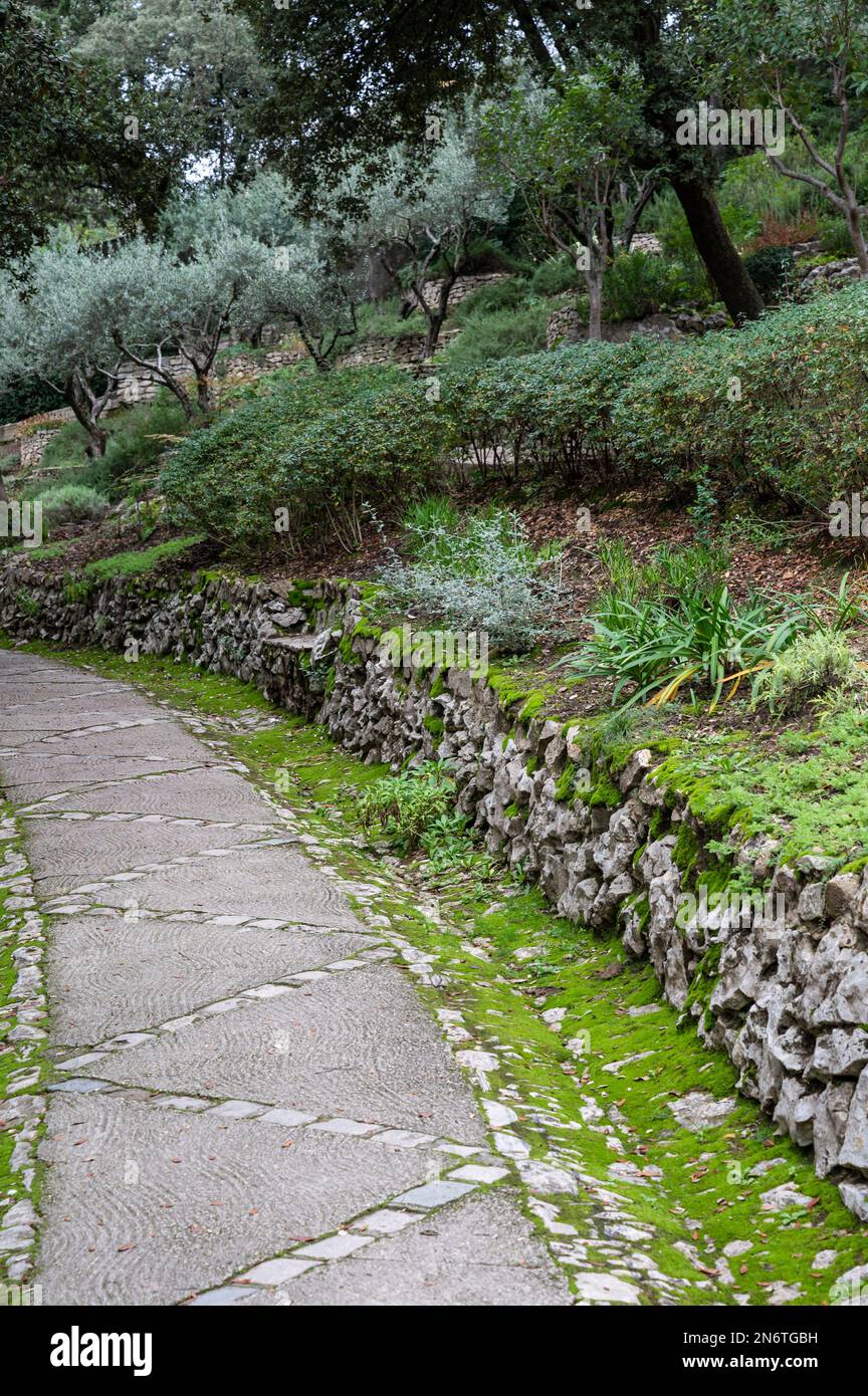 Empty path and green vegetation at a city park, Nimes, Occitanie ...