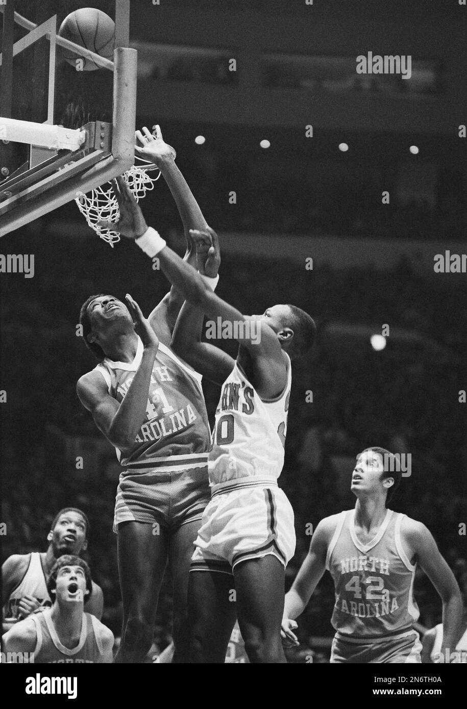 Sam Perkins (41) of the University of North Carolina, left, reaches for ...