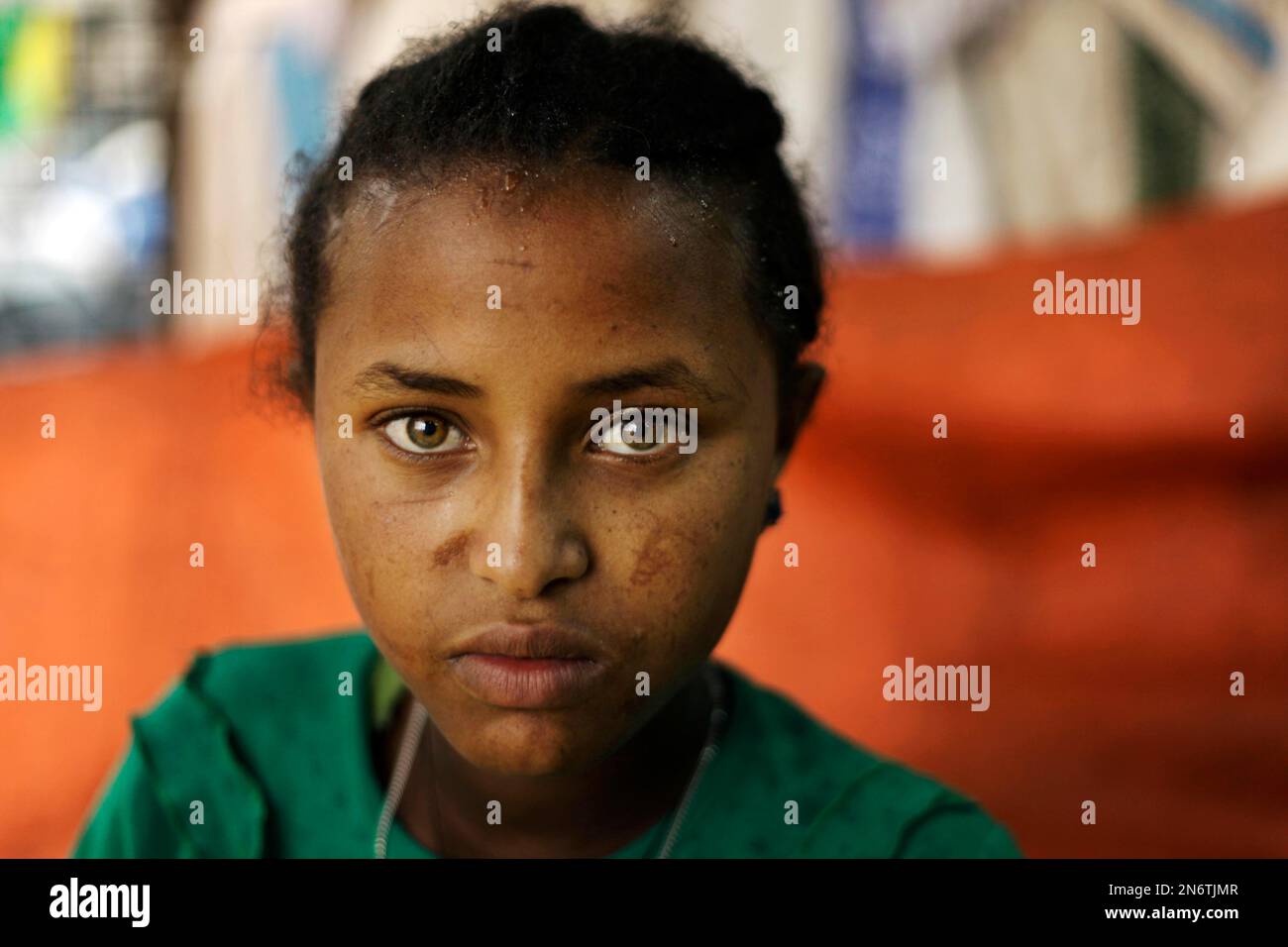 In this Saturday, Aug. 17, 2013 photo, an Ethiopian girl takes shelter ...