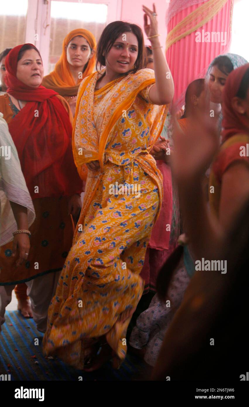 Hindu devotees dance as they worship Lord Krishna as part of ...