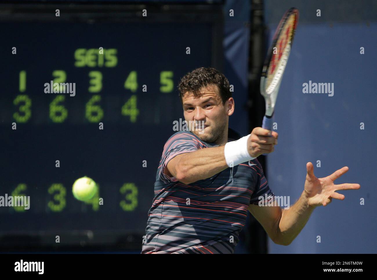 Grigor Dimitrov of Bulgaria returns a shot against Joao Sousa of ...