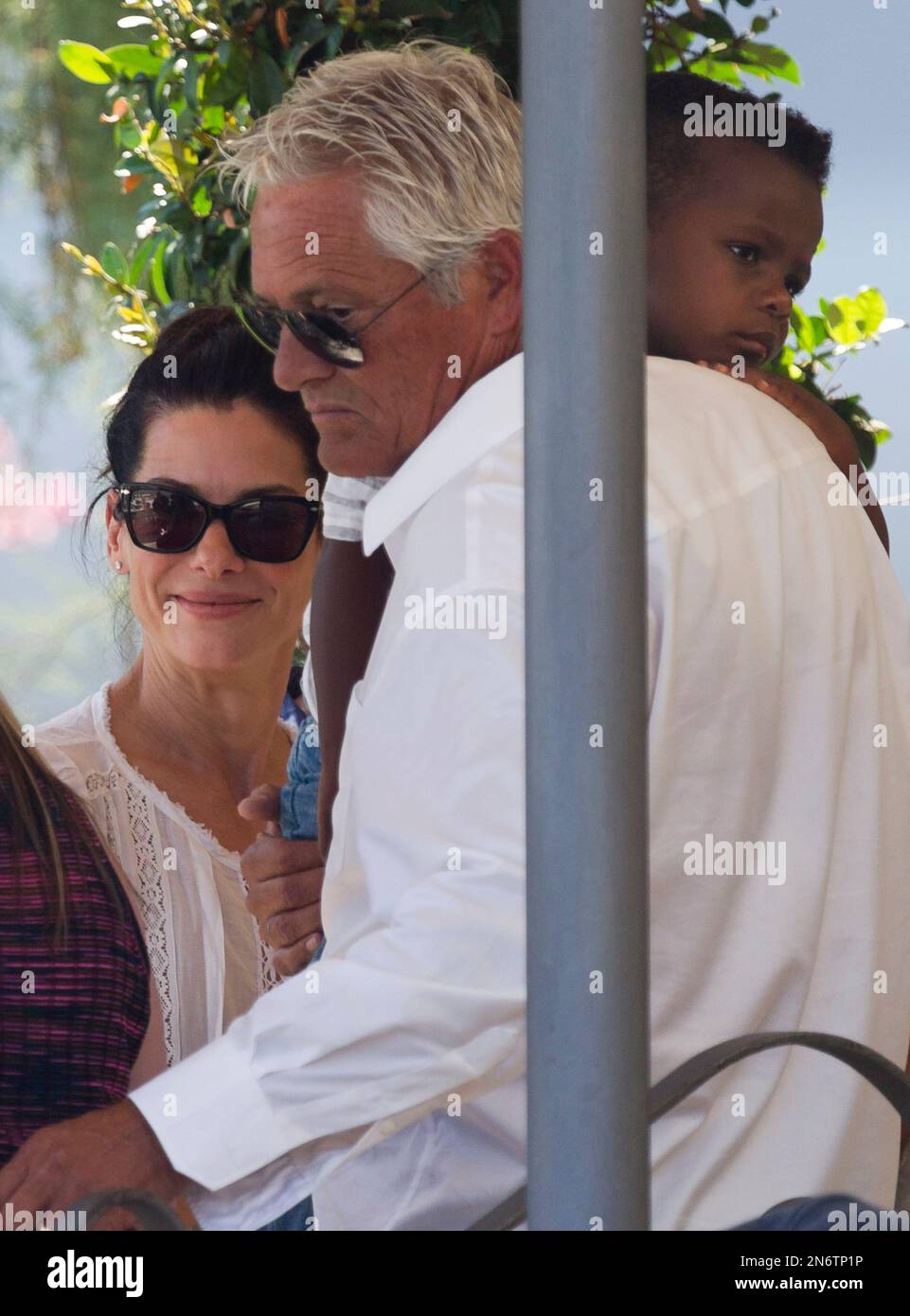 Actress Sandra Bullock, left, arrives with her child Louis Bardo, right ...