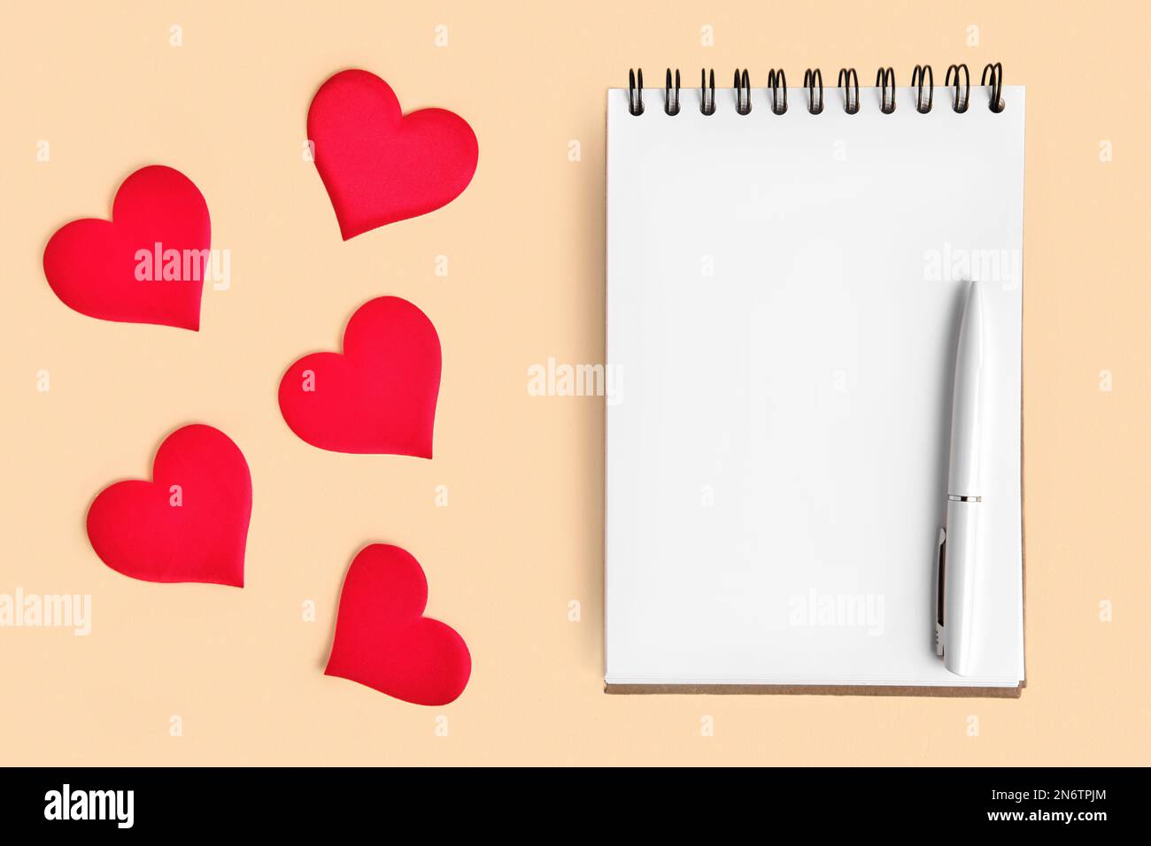 Notebook with pen, red heart. Open notebook on beige neutral color ...