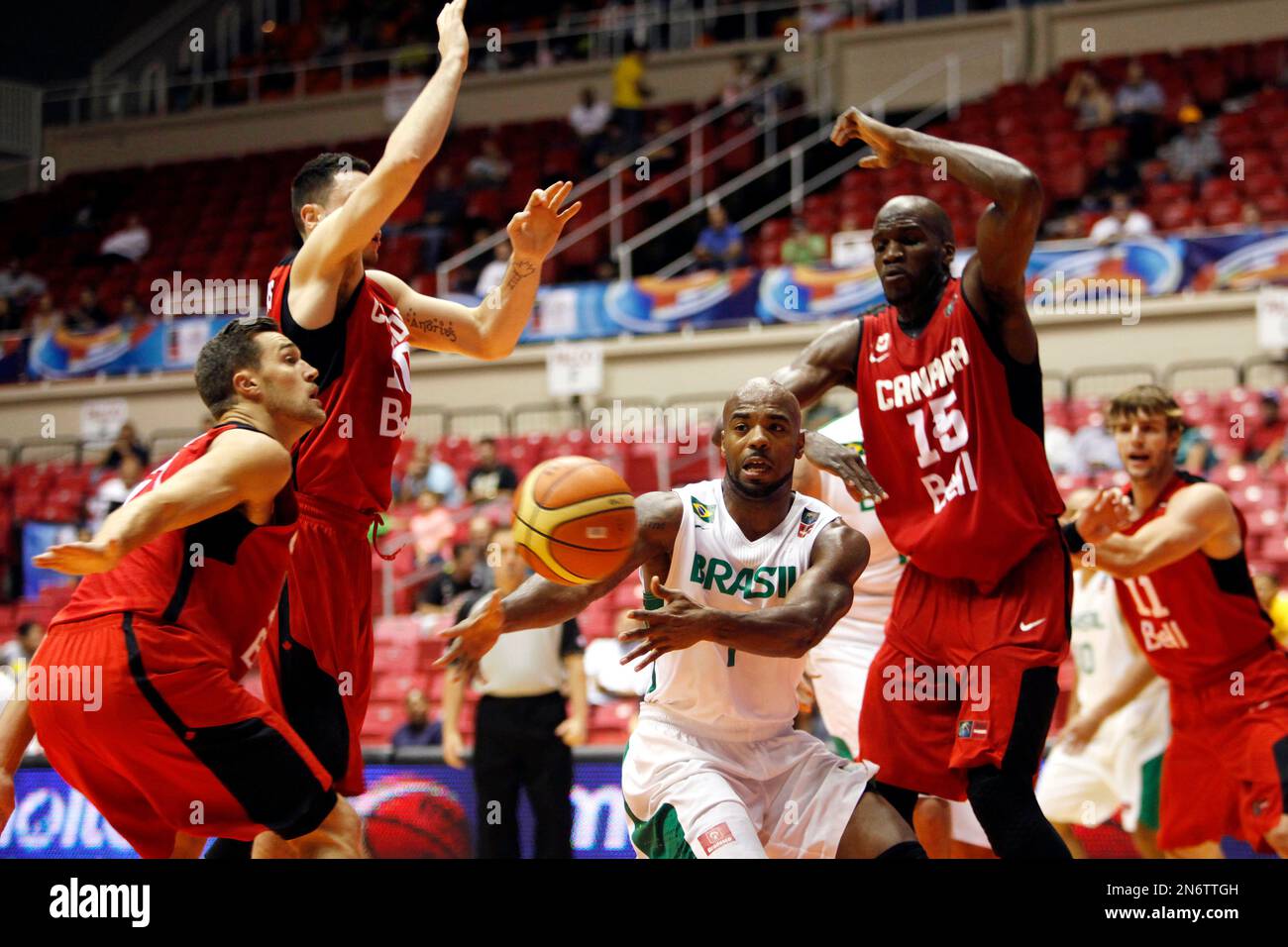 Brazil’s Larry Taylor, center, make a pass under pressure of Canada’s ...