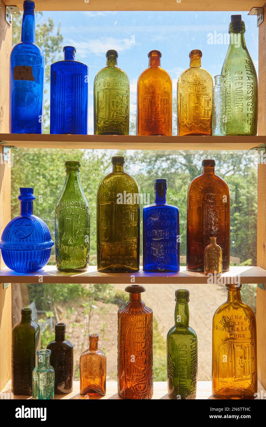 Glass bottles on a shelf, antique Stock Photo - Alamy