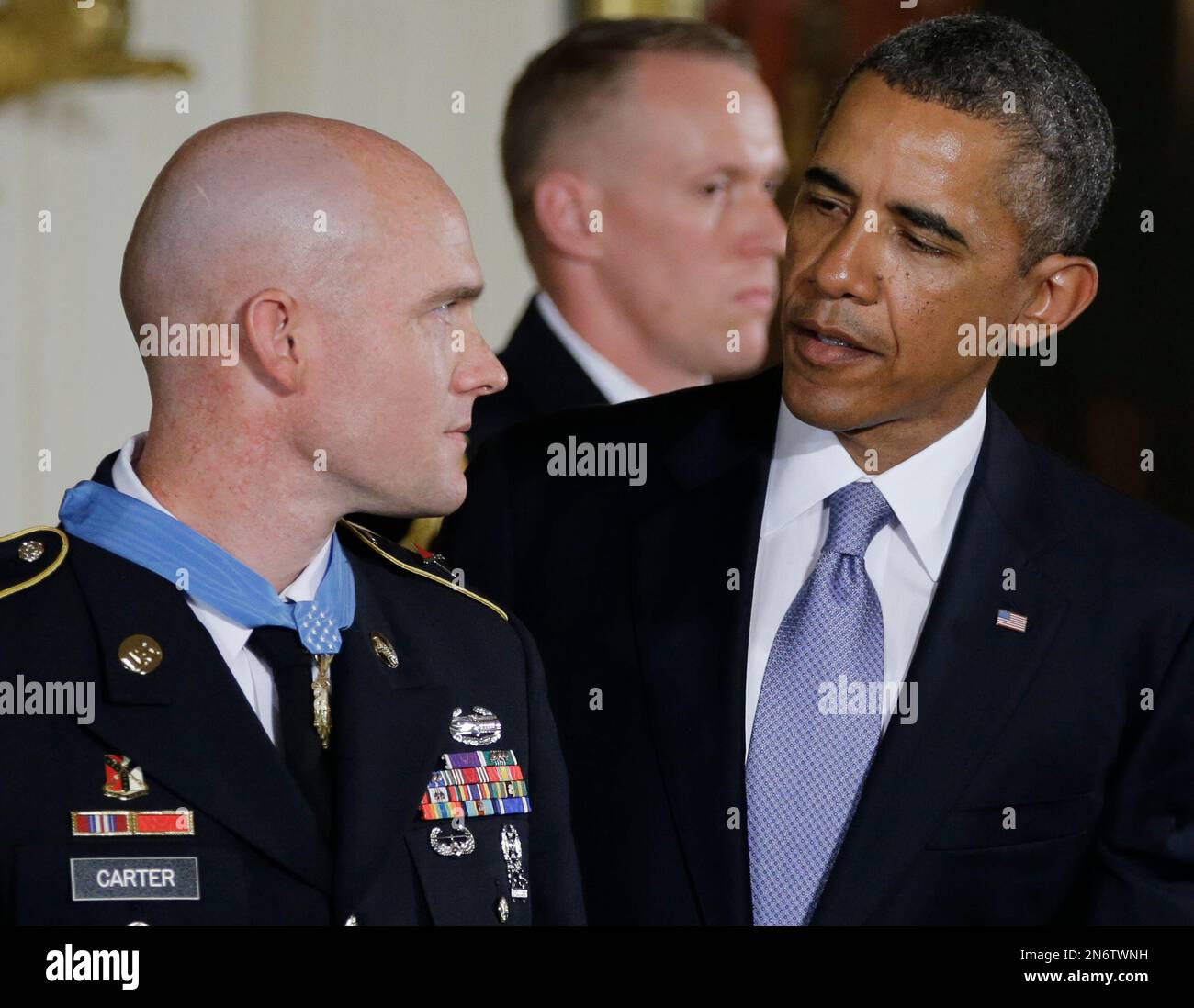 President Barack Obama loos to US Army Staff Sgt. Ty M. Carter after ...