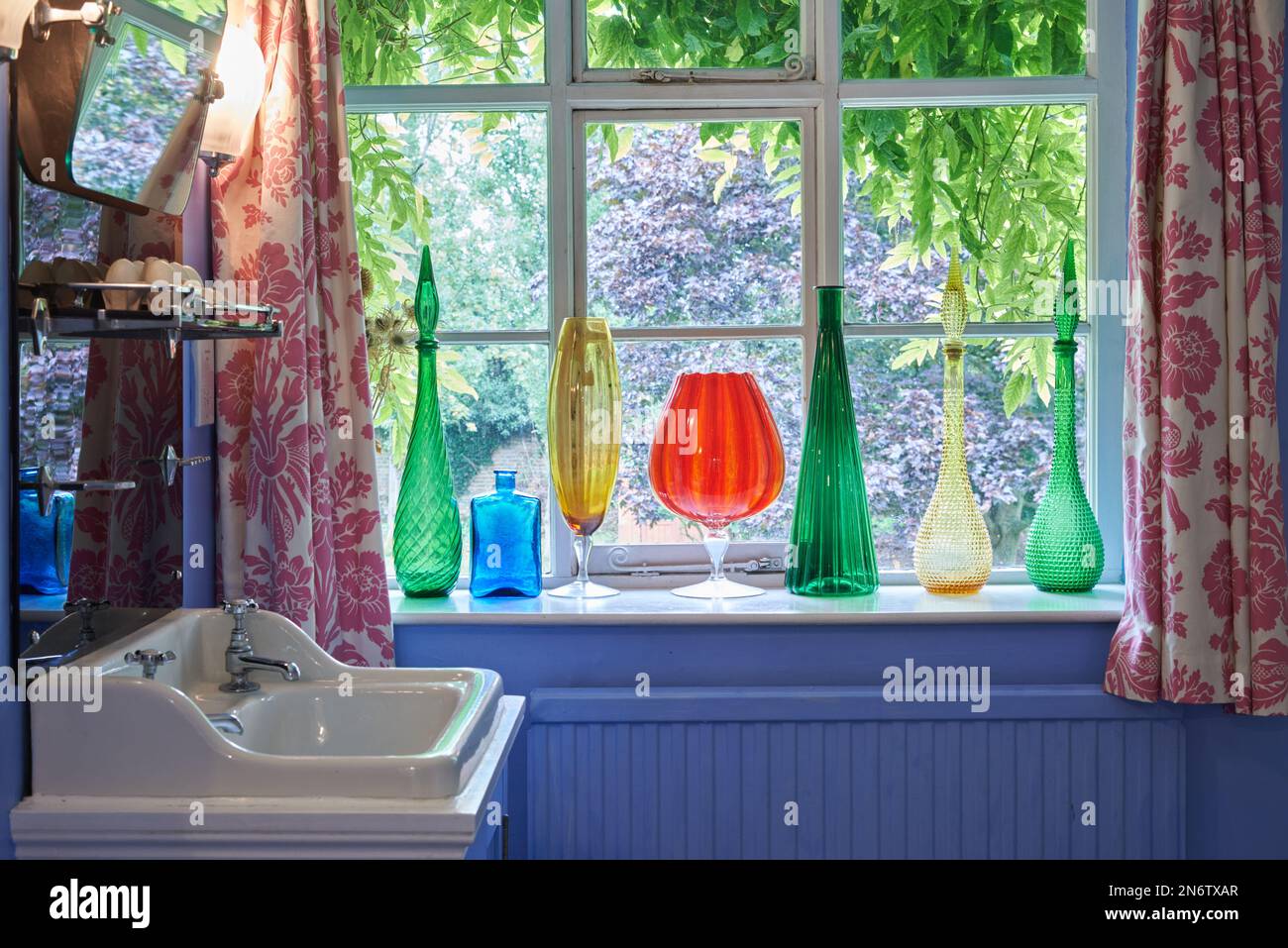 Glass bottles on a window sill Stock Photo - Alamy